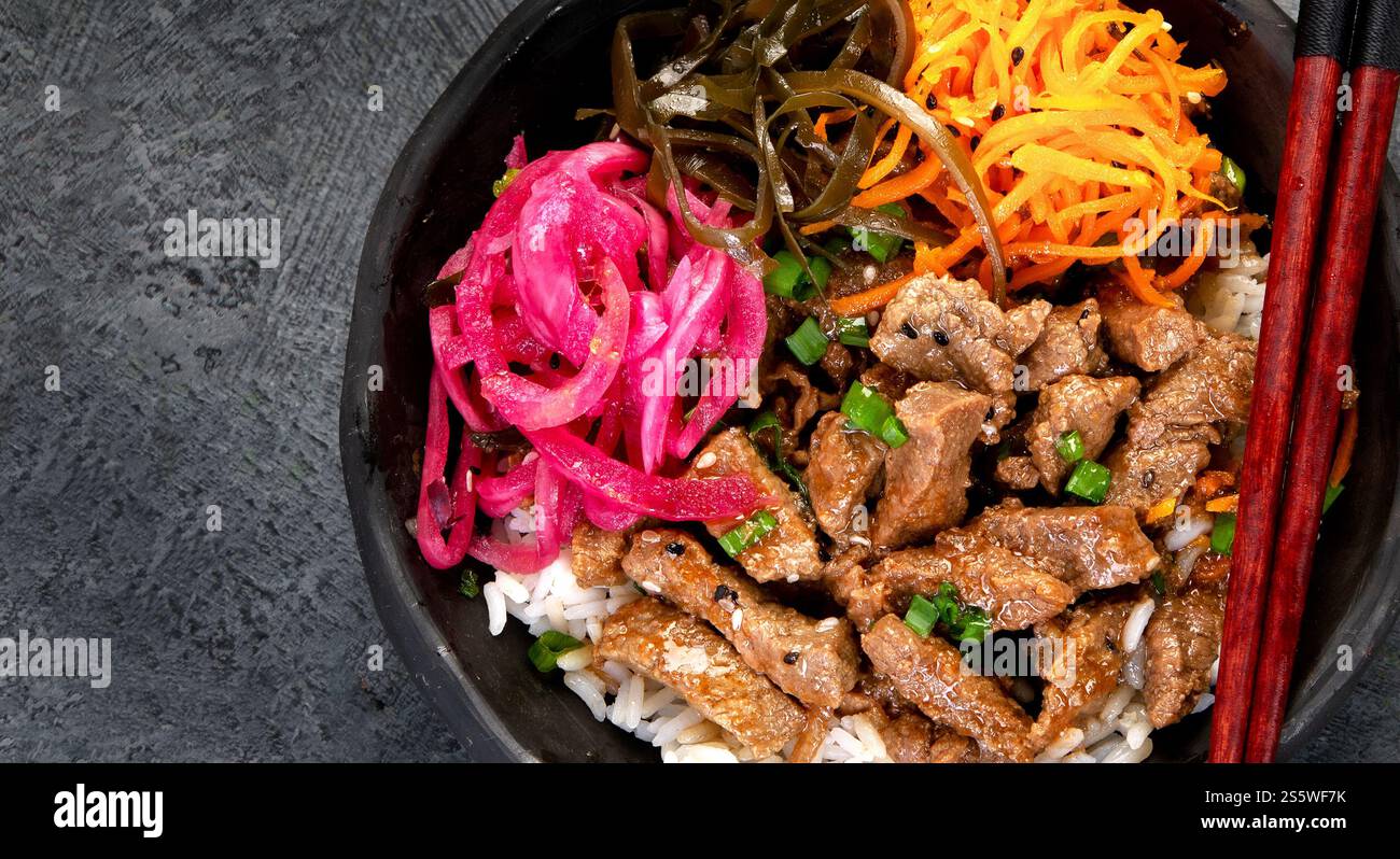 Bulgogi with meat on dark background. Traditional Korean food. Top view ...