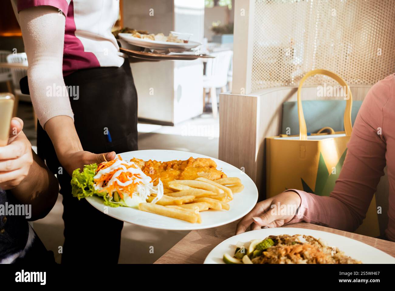 Restaurant waitress serve plates full of meals to the customer Stock ...