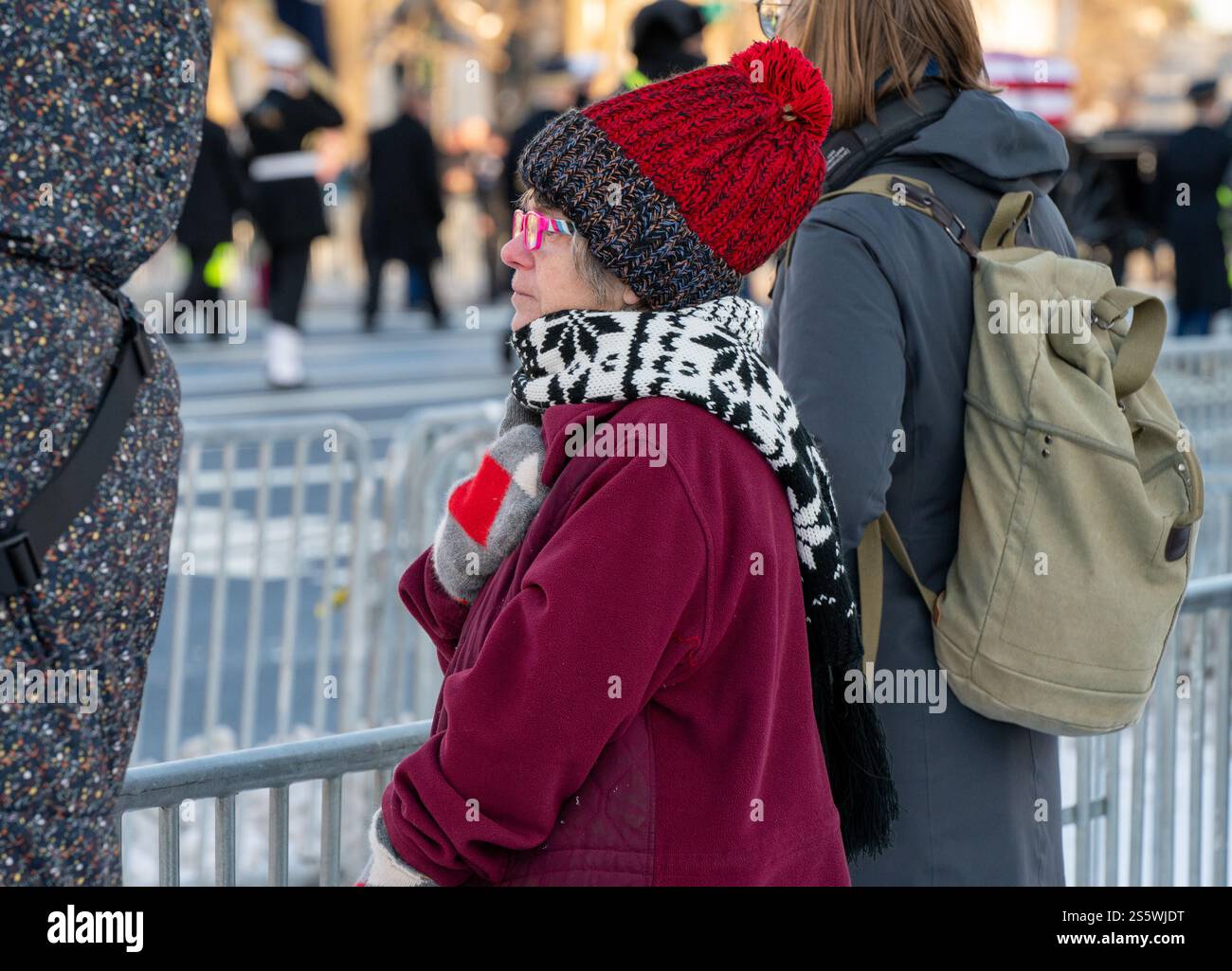 A woman holds her hand over her heart as President Jimmy Carter's ...