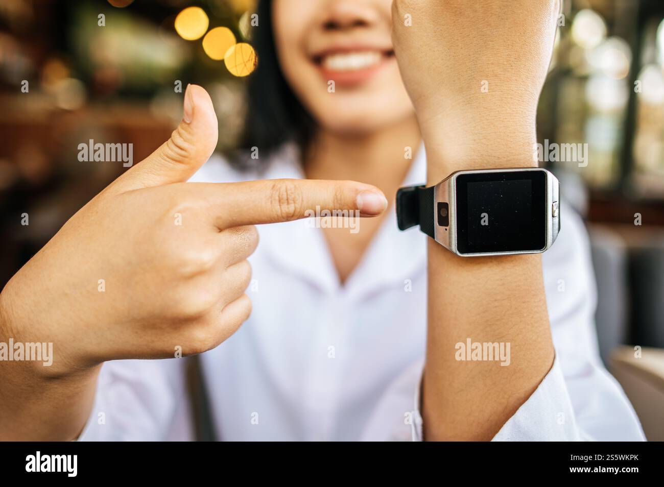 A smart watch on the wrist with a right hand pointing at it Stock Photo ...