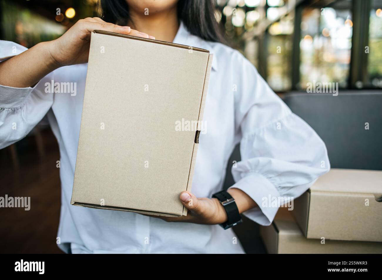 Woman holding parcel box hi-res stock photography and images - Alamy