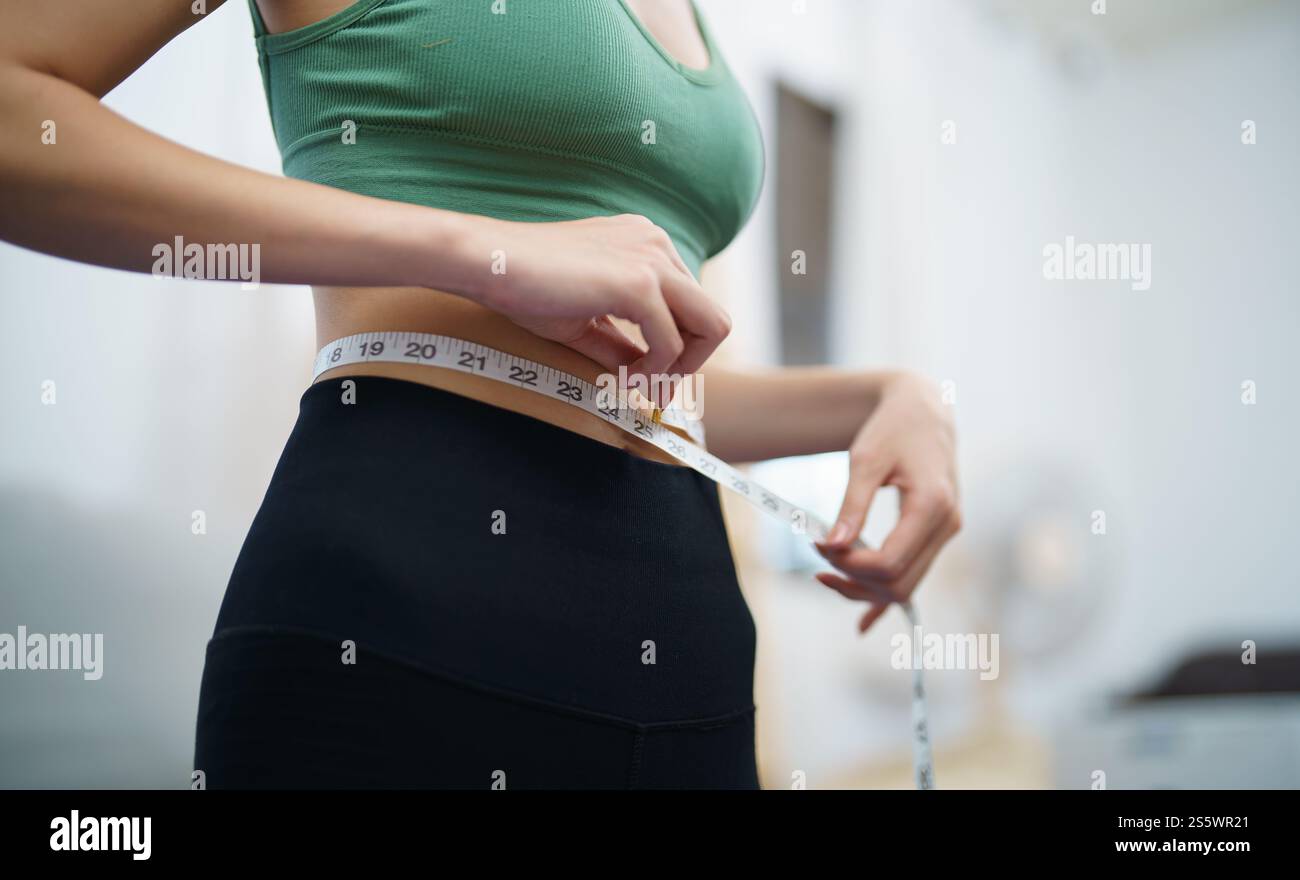 Asian woman with anorexia with measuring tape feeling unhappy. Anorexia ...