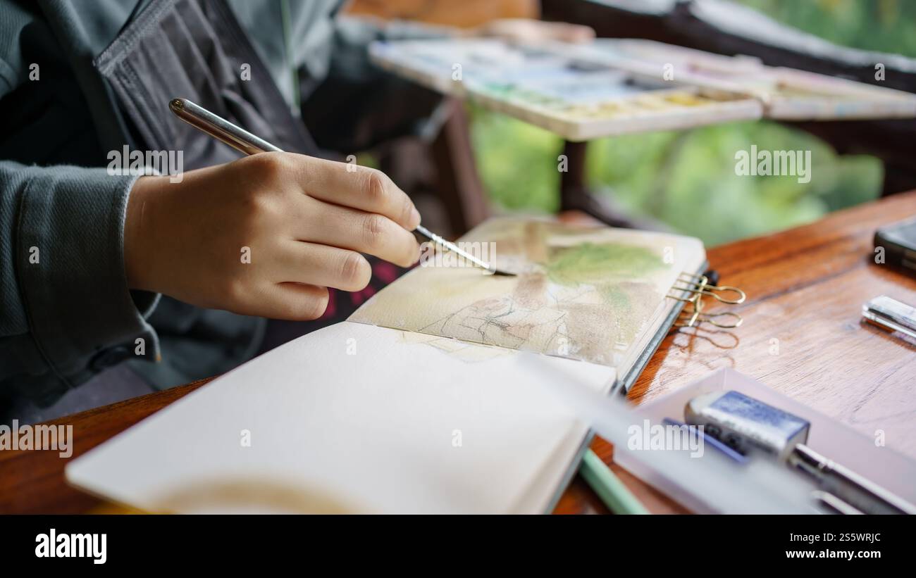 Student in classes at art studio. Hand holding artist brush mix color ...