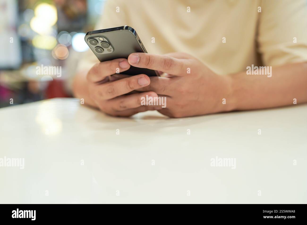 Relaxed young asian man using smart phone spending time checking news ...