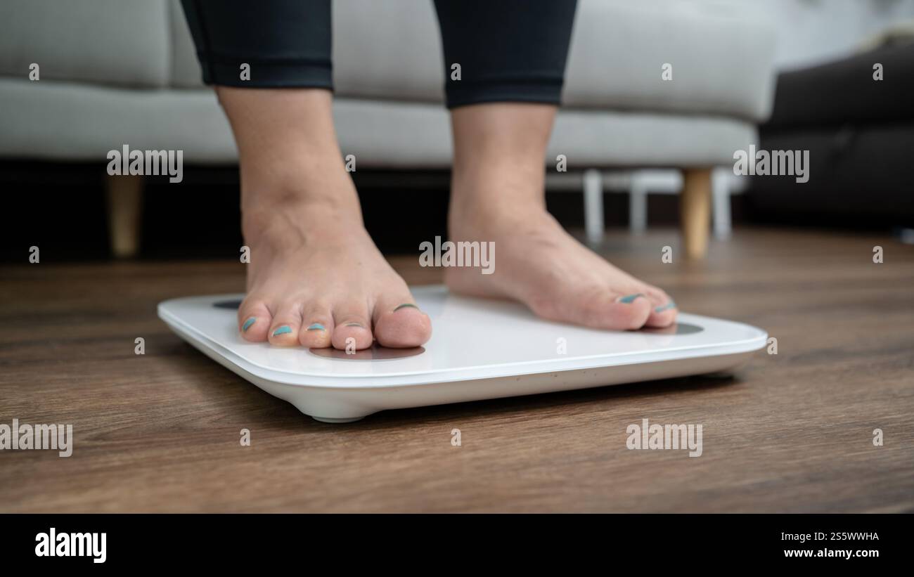 Fat diet and scale feet standing on electronic scales for weight ...