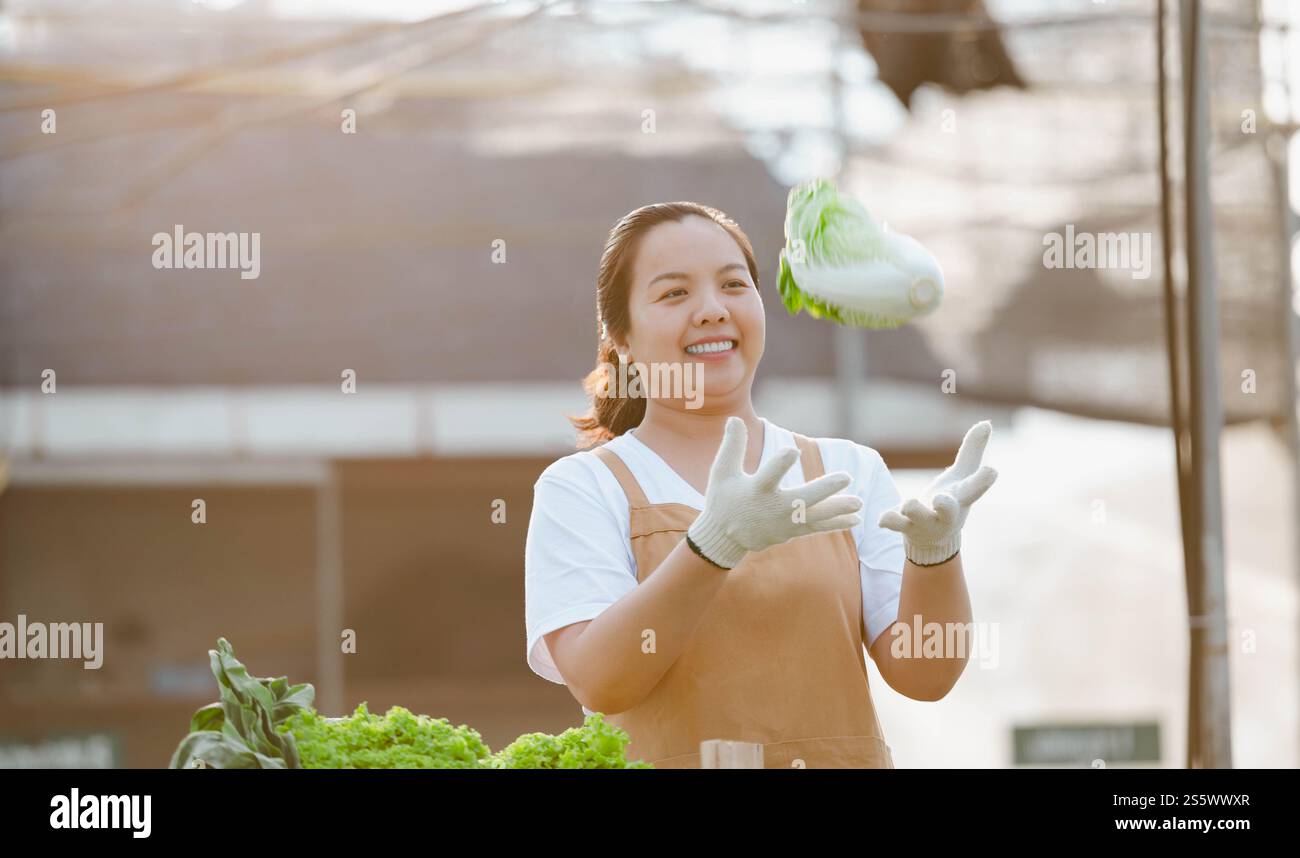 Asian farmer woman showing quality vegetable in organic vegetable hydroponic farm. Plantation ...