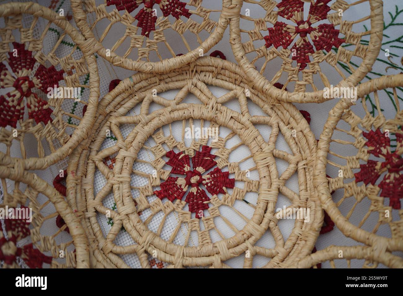 Cretan basket traditionally woven with patterns of red flowers ...