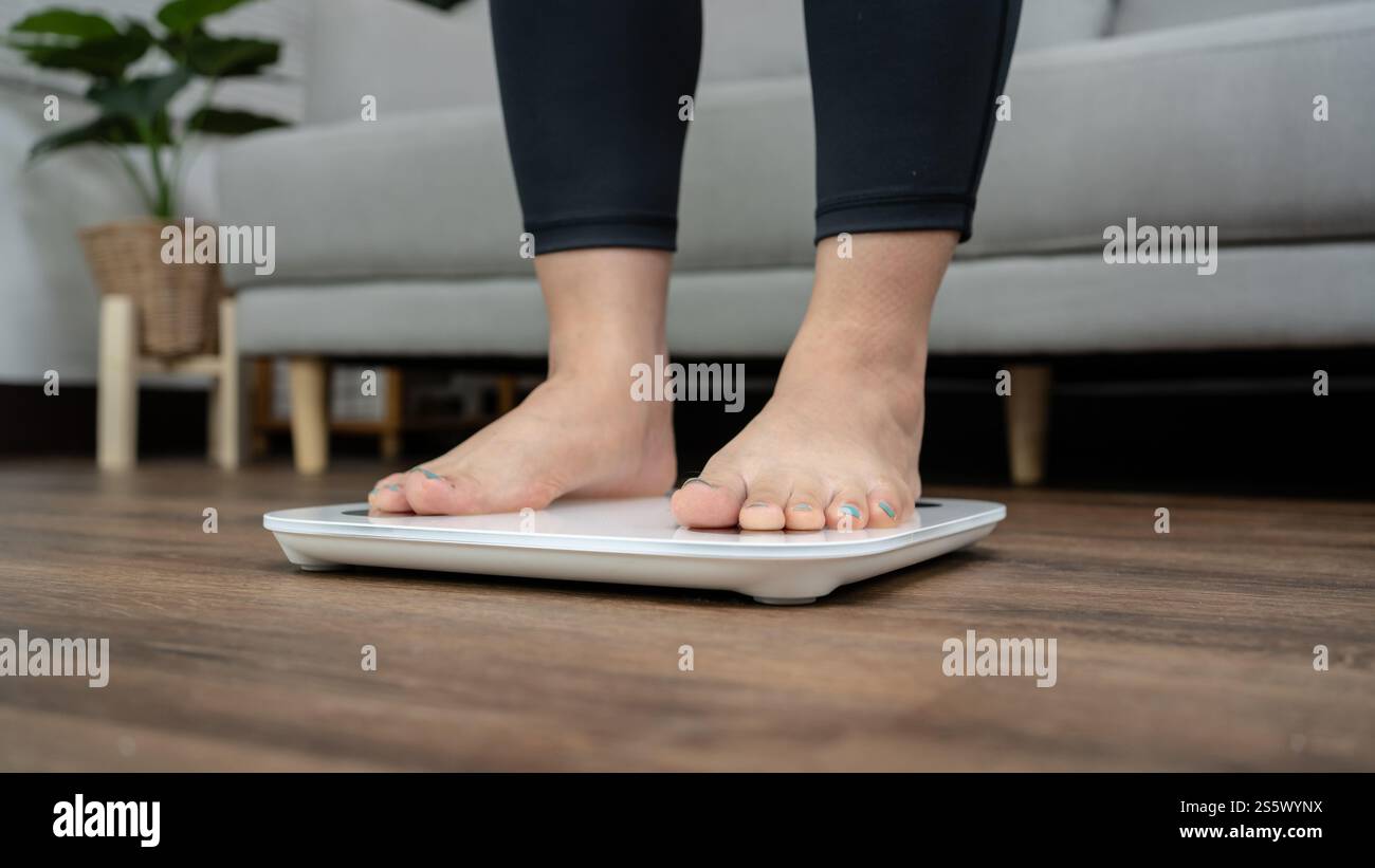 feet standing on electronic scales for weight control. Measurement ...