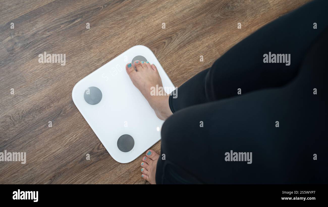 feet standing on electronic scales for weight control. Measurement ...