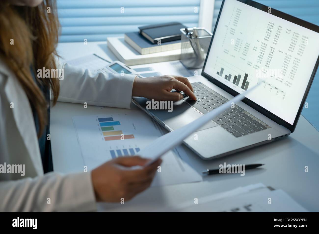 Alone Working Late at Night. Asian business woman at workplace in ...