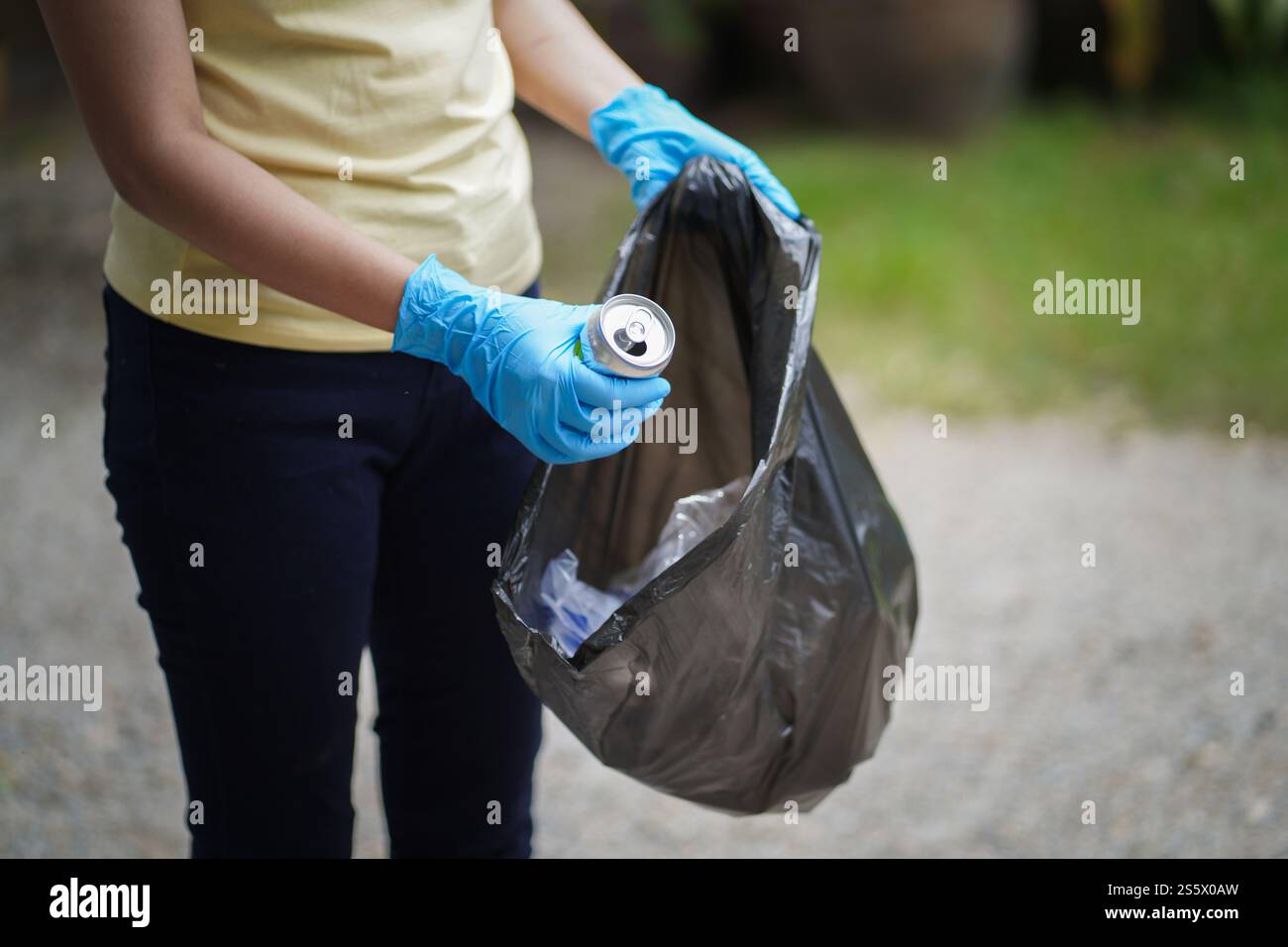 Volunteer charity woman hand holding garbage black bag and plastic ...
