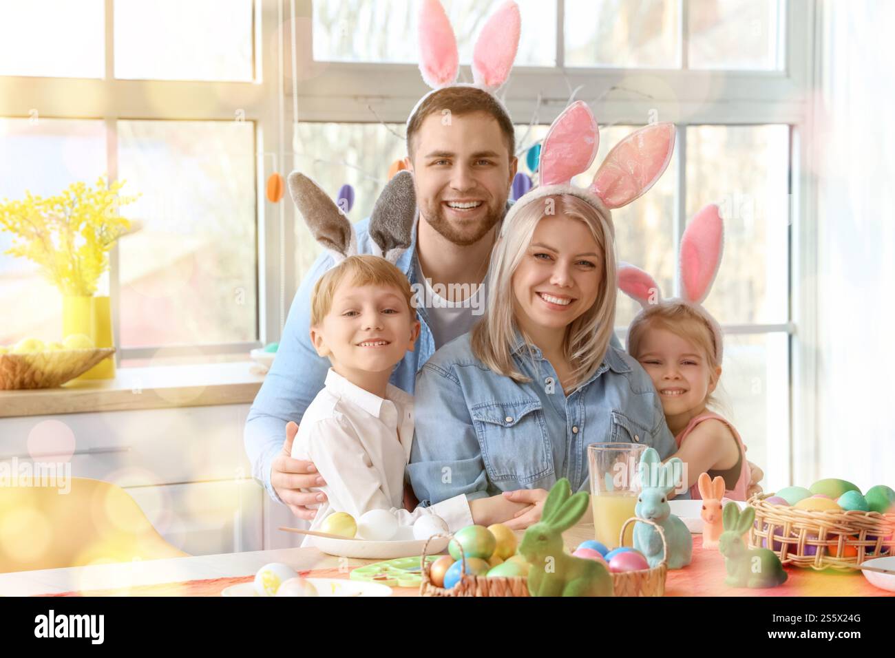 Happy family celebrating Easter at home Stock Photo - Alamy