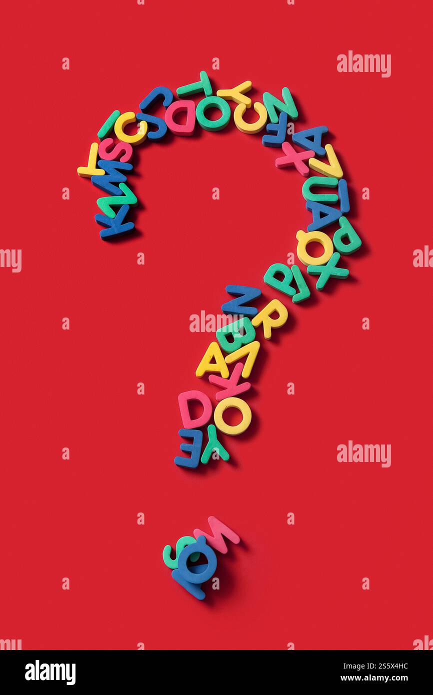 Question mark made of different colorful letters on red background ...