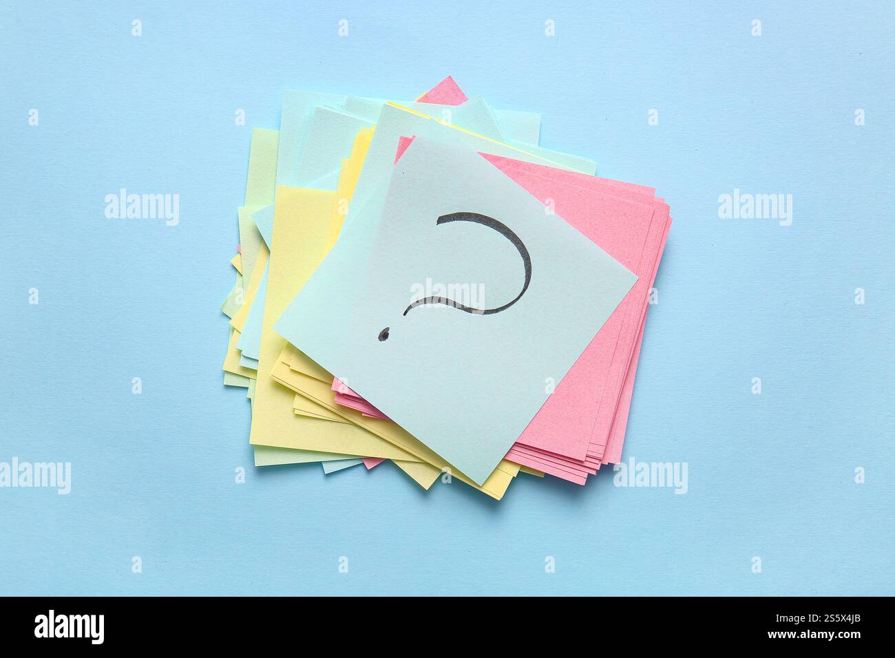 Heap of different sticky notes with question mark on color background ...