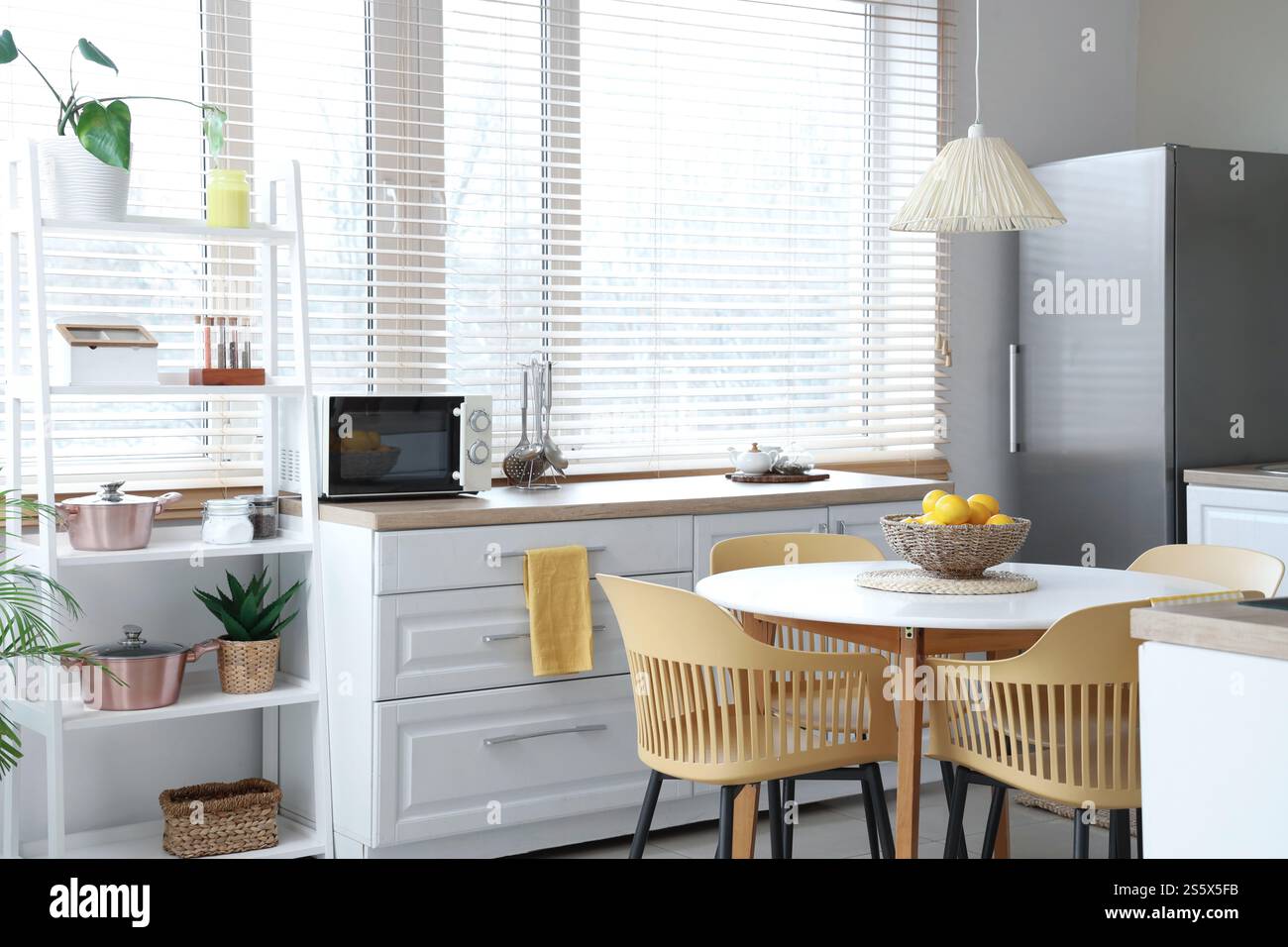 Interior of kitchen with dining table, counters and shelf unit Stock ...
