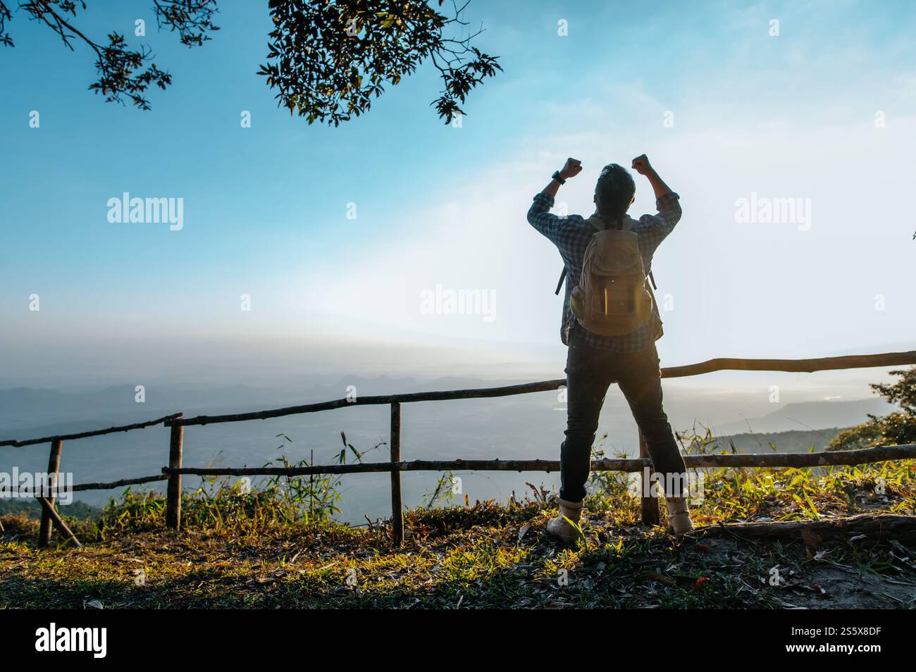 Rear view back of Young asian hiking man standing at view point and ...