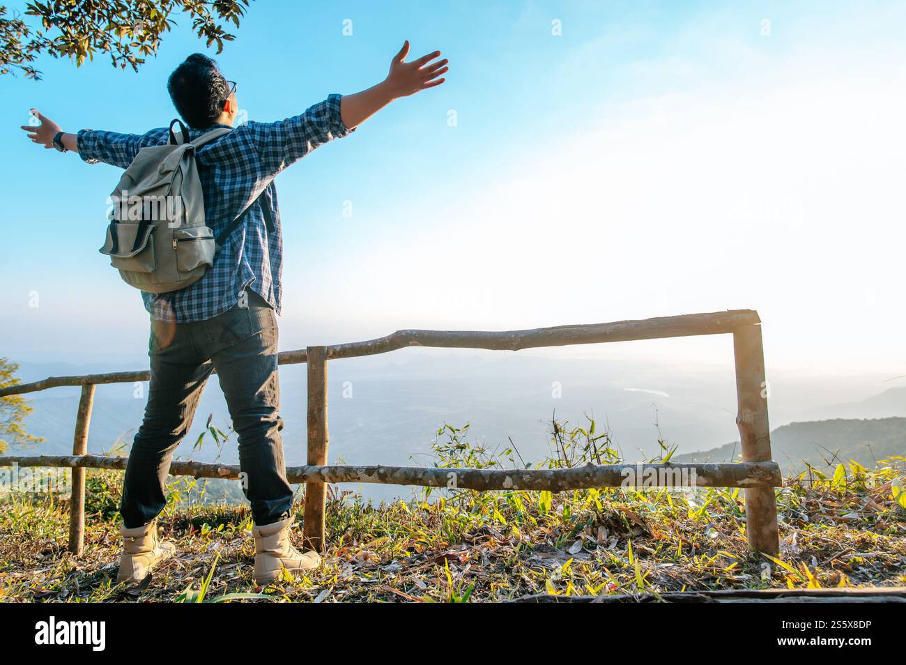 Rear view back of Young asian hiking man standing at view point and ...
