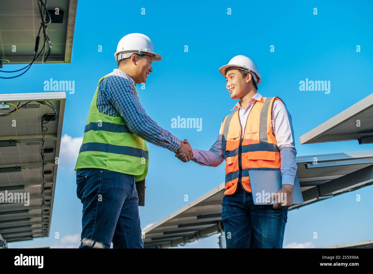 Asian Young technician man and Engineer shaking hands and smile with ...