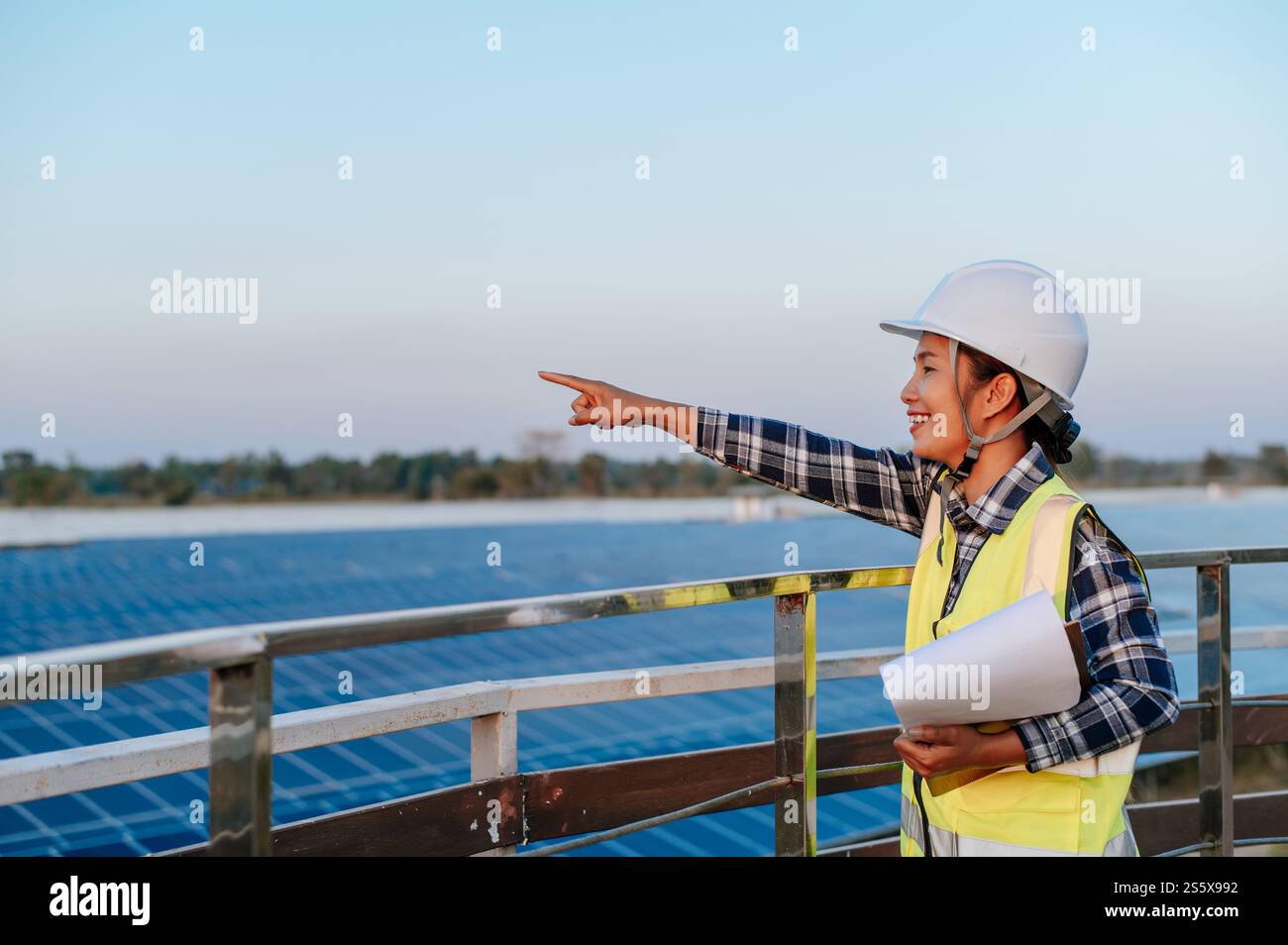 Cheerful Young asian female inspector engineer point finger forward ...