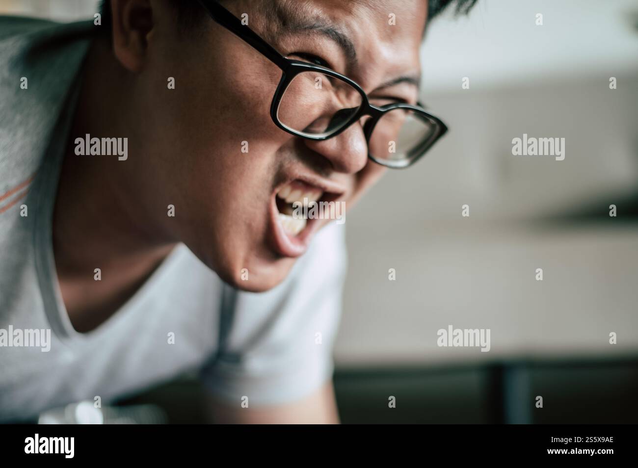 Funny overweight man in glasses try to planking on the floor doing ...