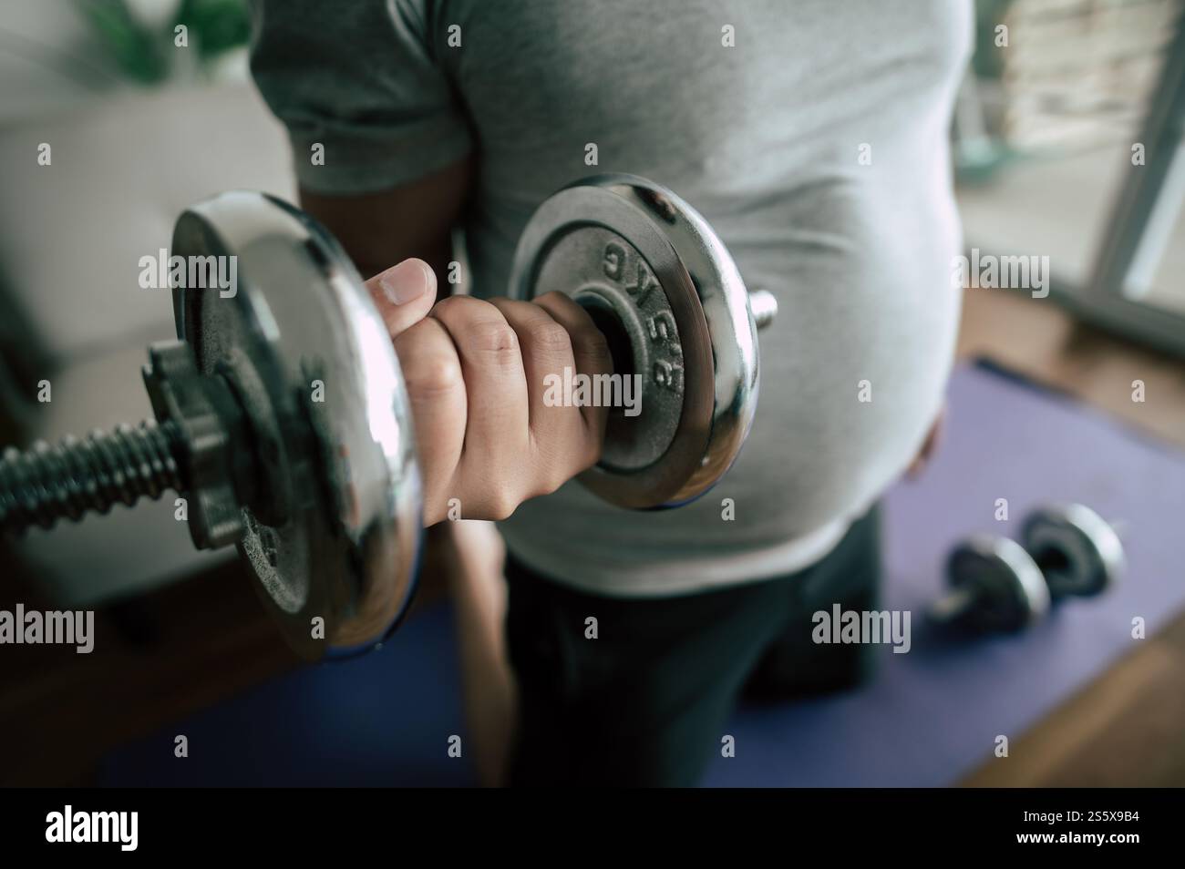 Selective focus, Close up male hand lifting up a dumbbell to exercise ...
