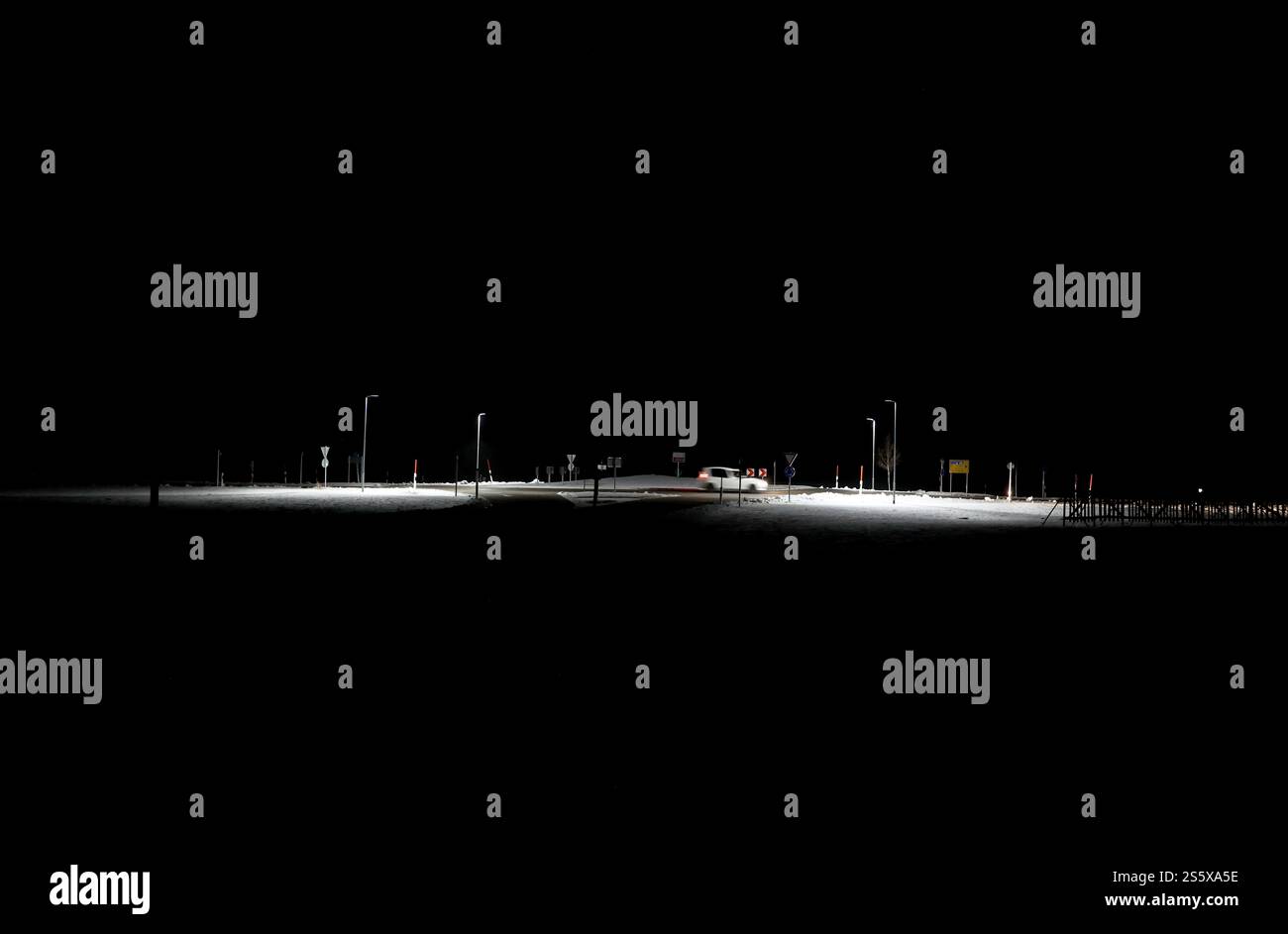Seeg, Germany. 15th Jan, 2025. A car drives through a traffic circle in ...