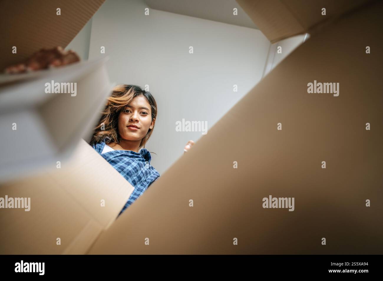 Inside of package view, Selective focus, Young pretty woman opens ...