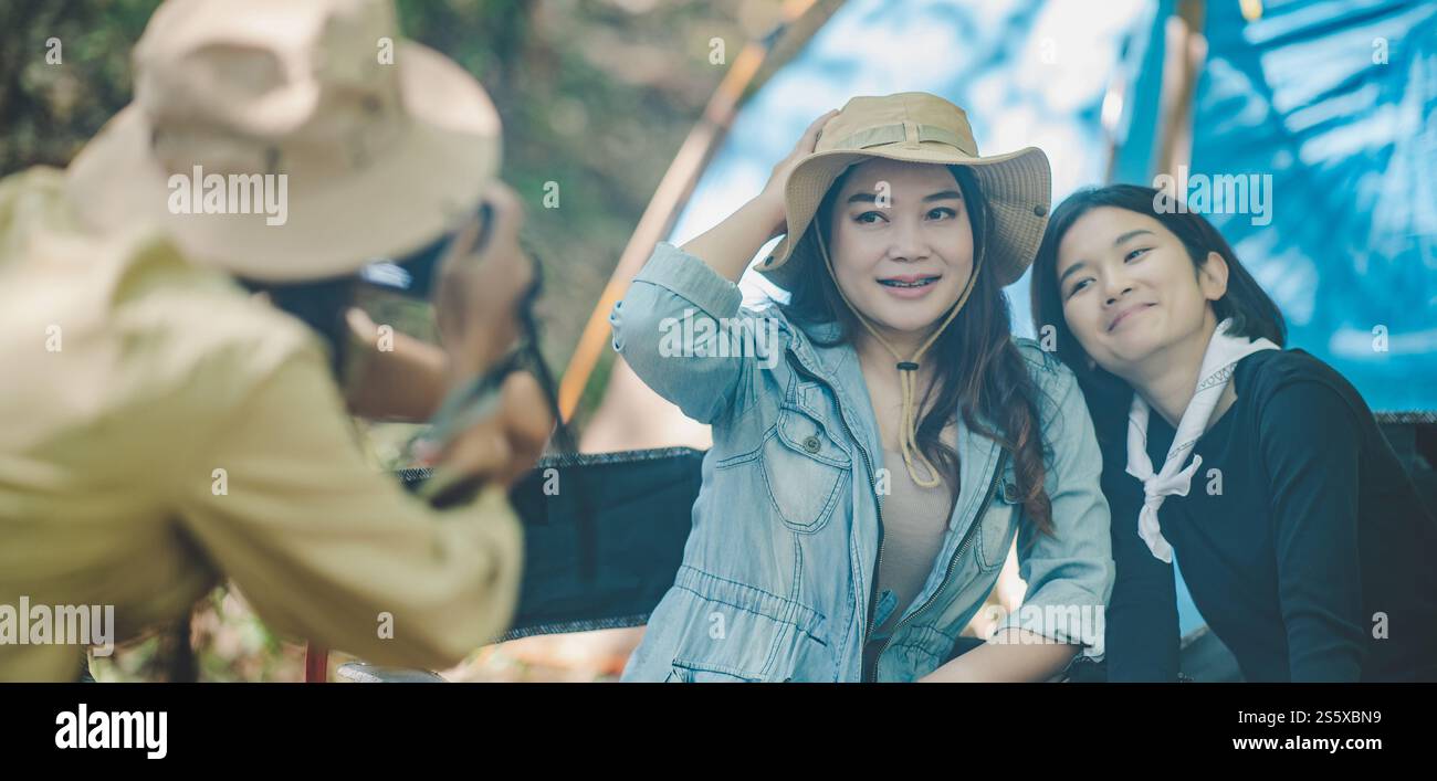 Young female photographer enjoy to take photo her friends, she use ...