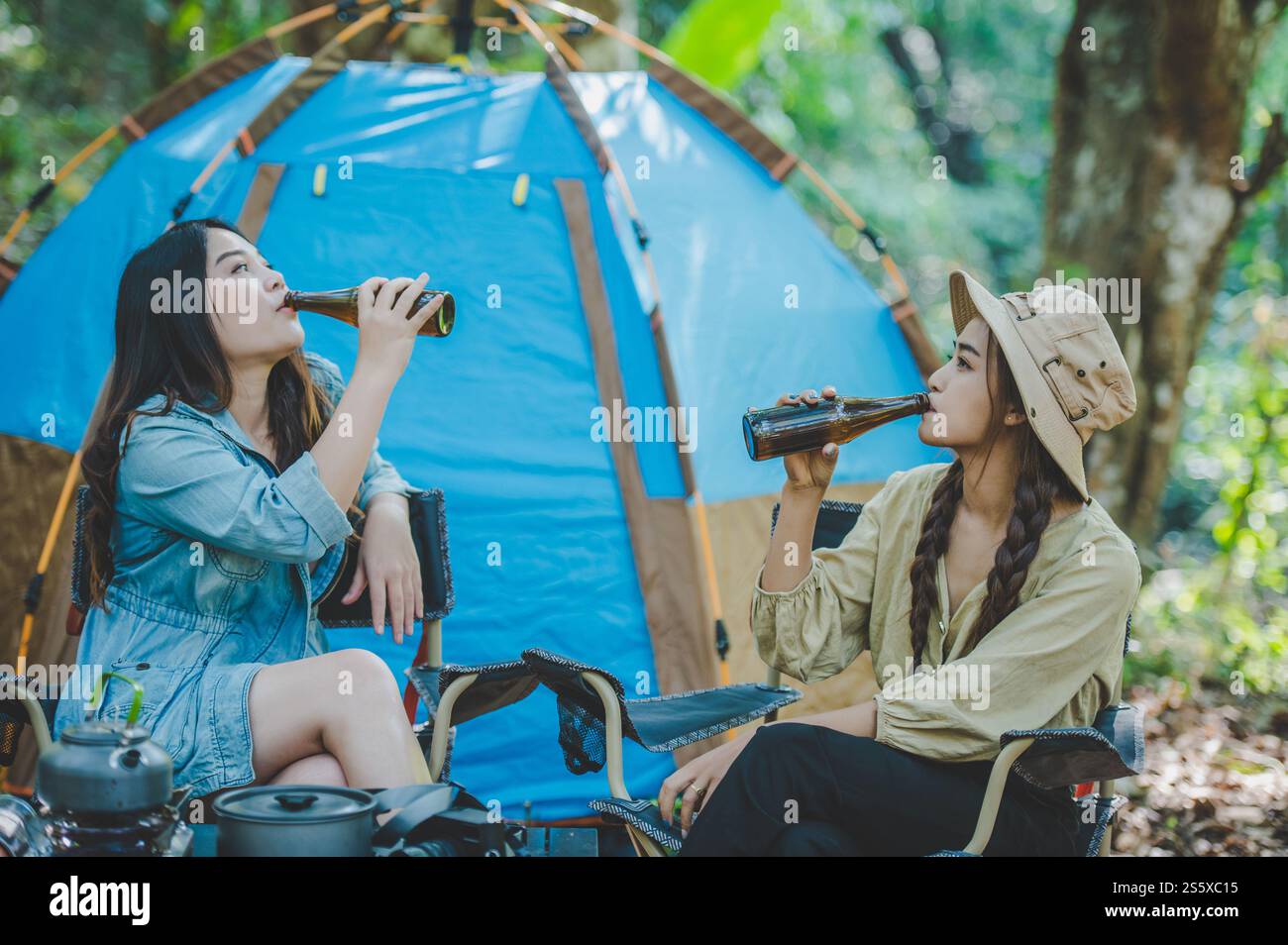 Group beautiful Asian women friends travelers relaxing in camp chairs ...