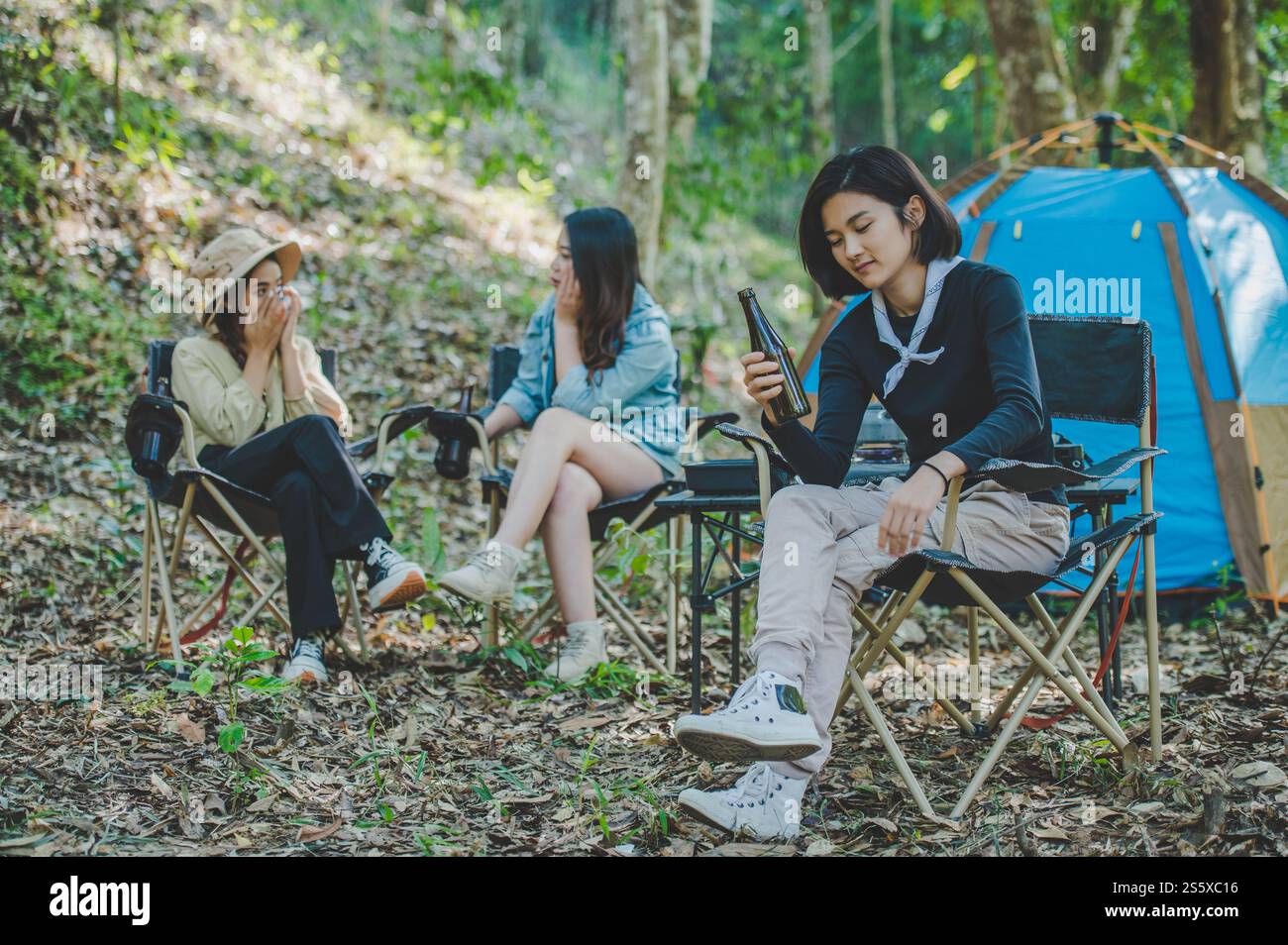 Group beautiful Asian women friends travelers relaxing in camp chairs ...