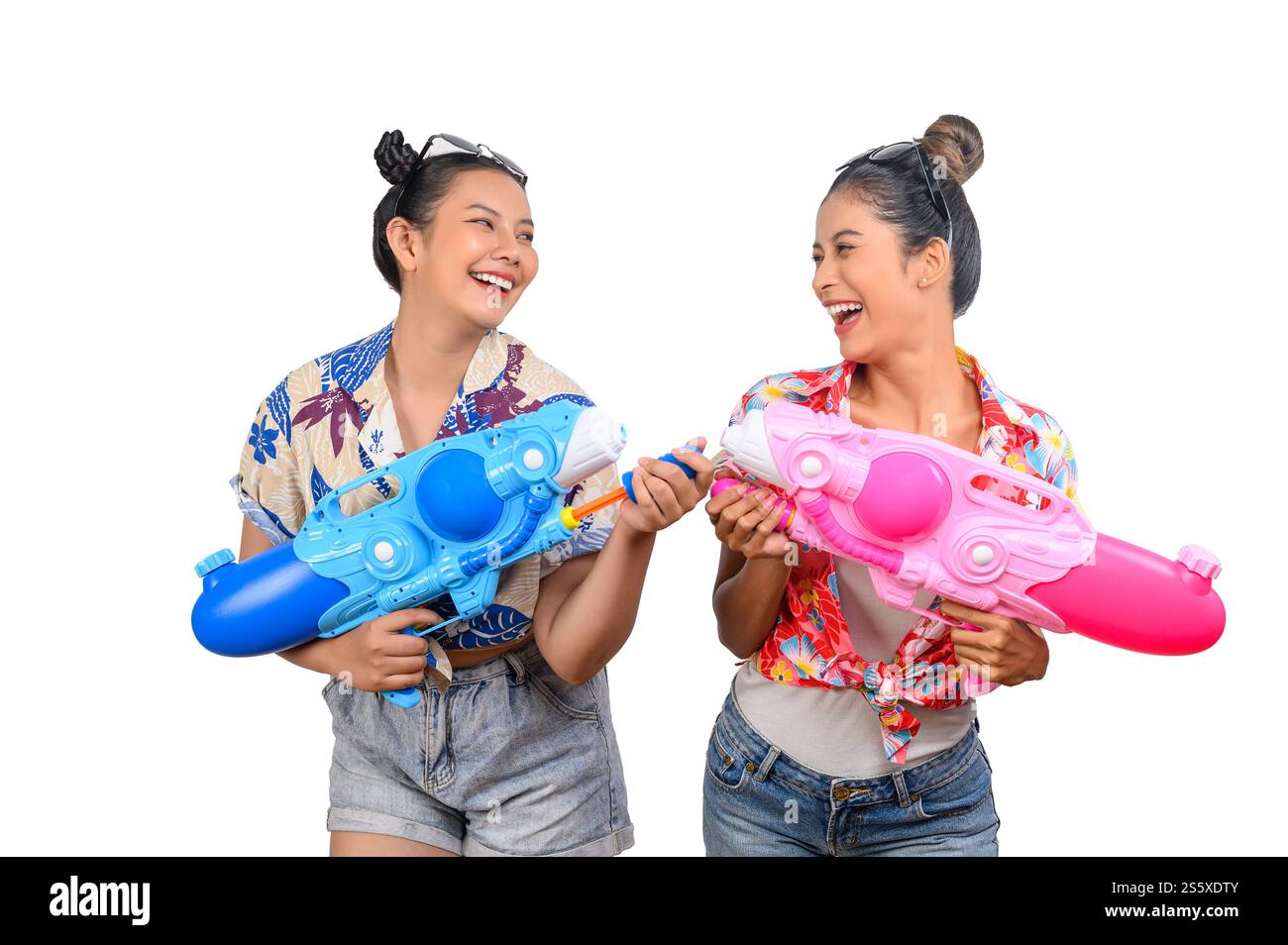 Portrait two women in floral shirt and short jeans holding water gun ...