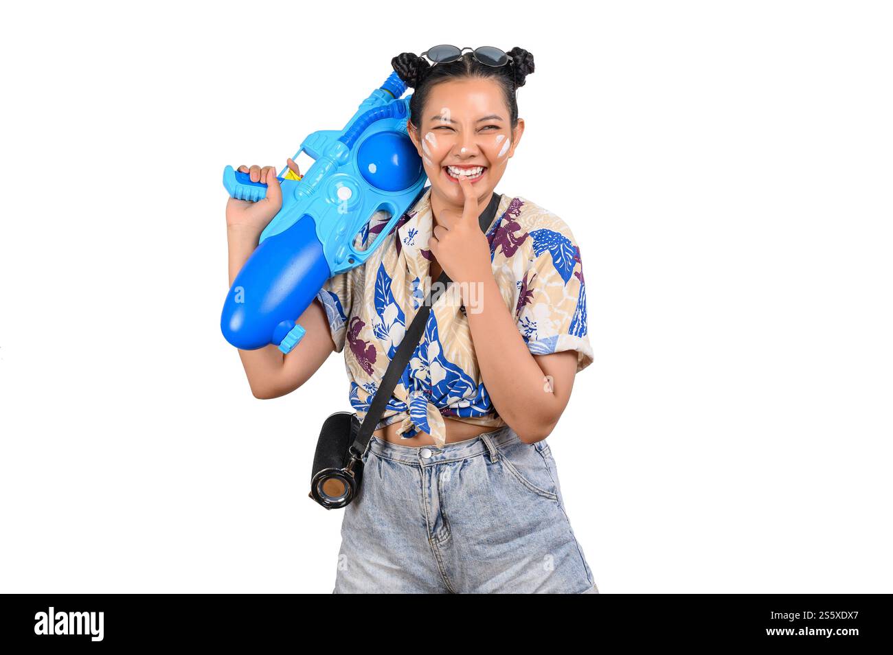 Portrait lovely woman in floral shirt and short jeans holding water gun ...