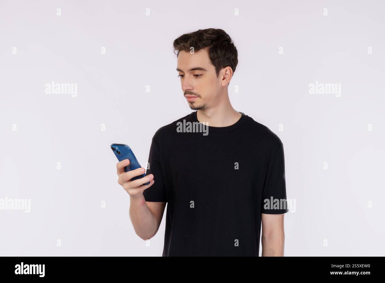 Portrait of a happy businessman using smartphone over white background ...