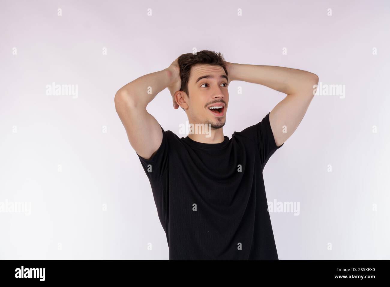 Portrait of surprised man screams with joy while holding his hands ...