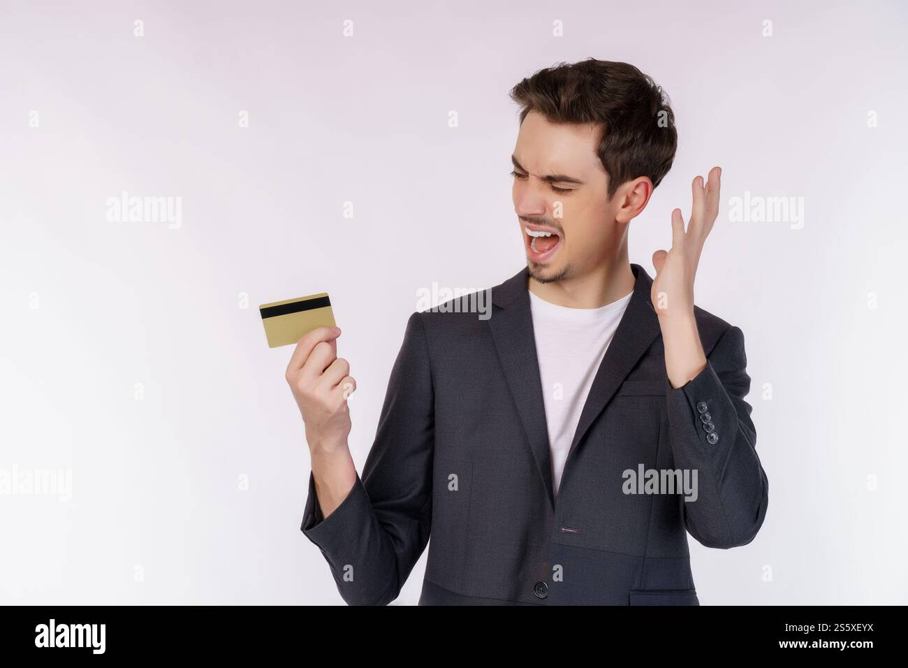 Portrait of unhappy businessman showing credit card isolated over white ...
