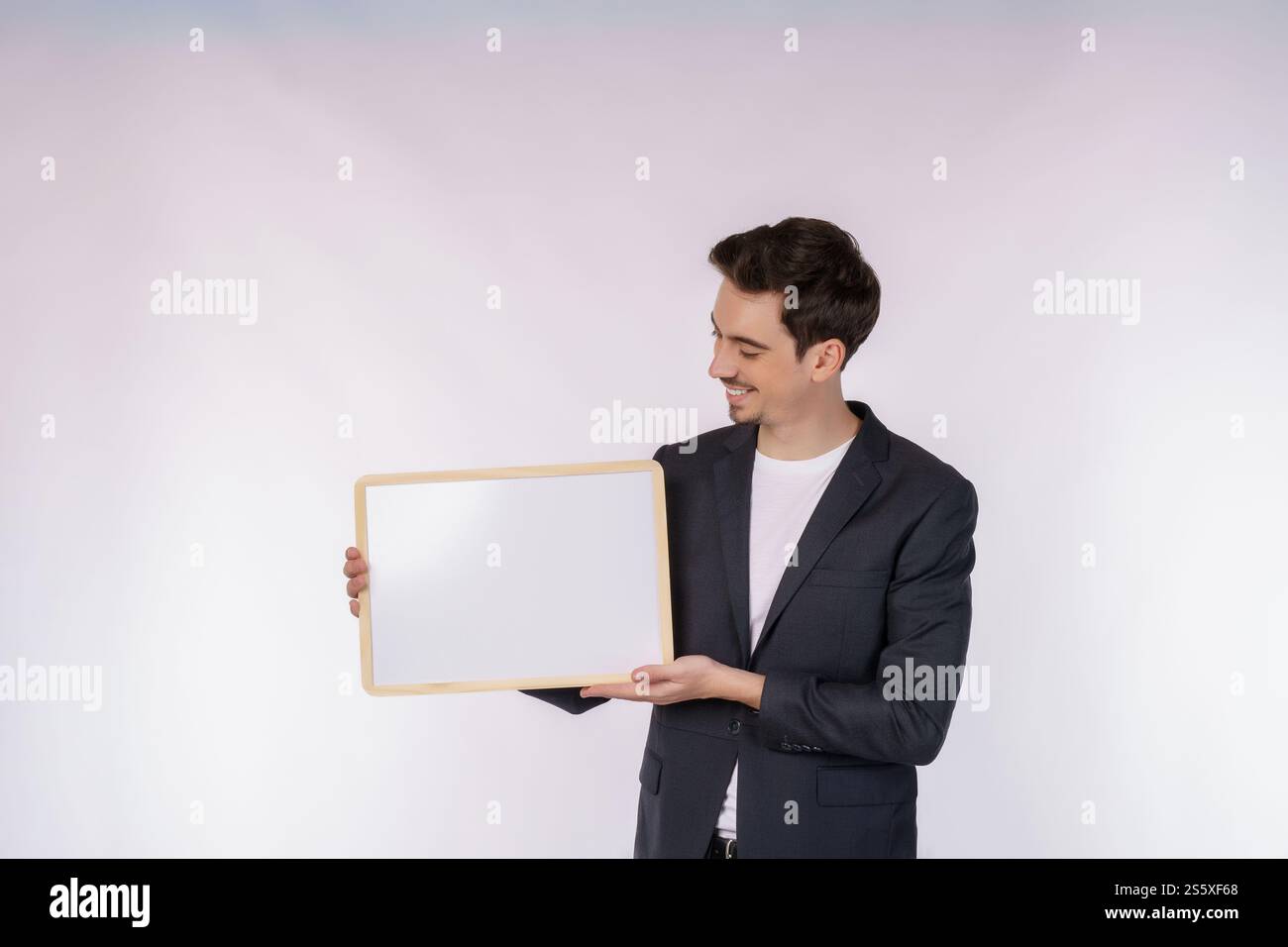Portrait of happy businessman showing blank signboard on isolated white ...