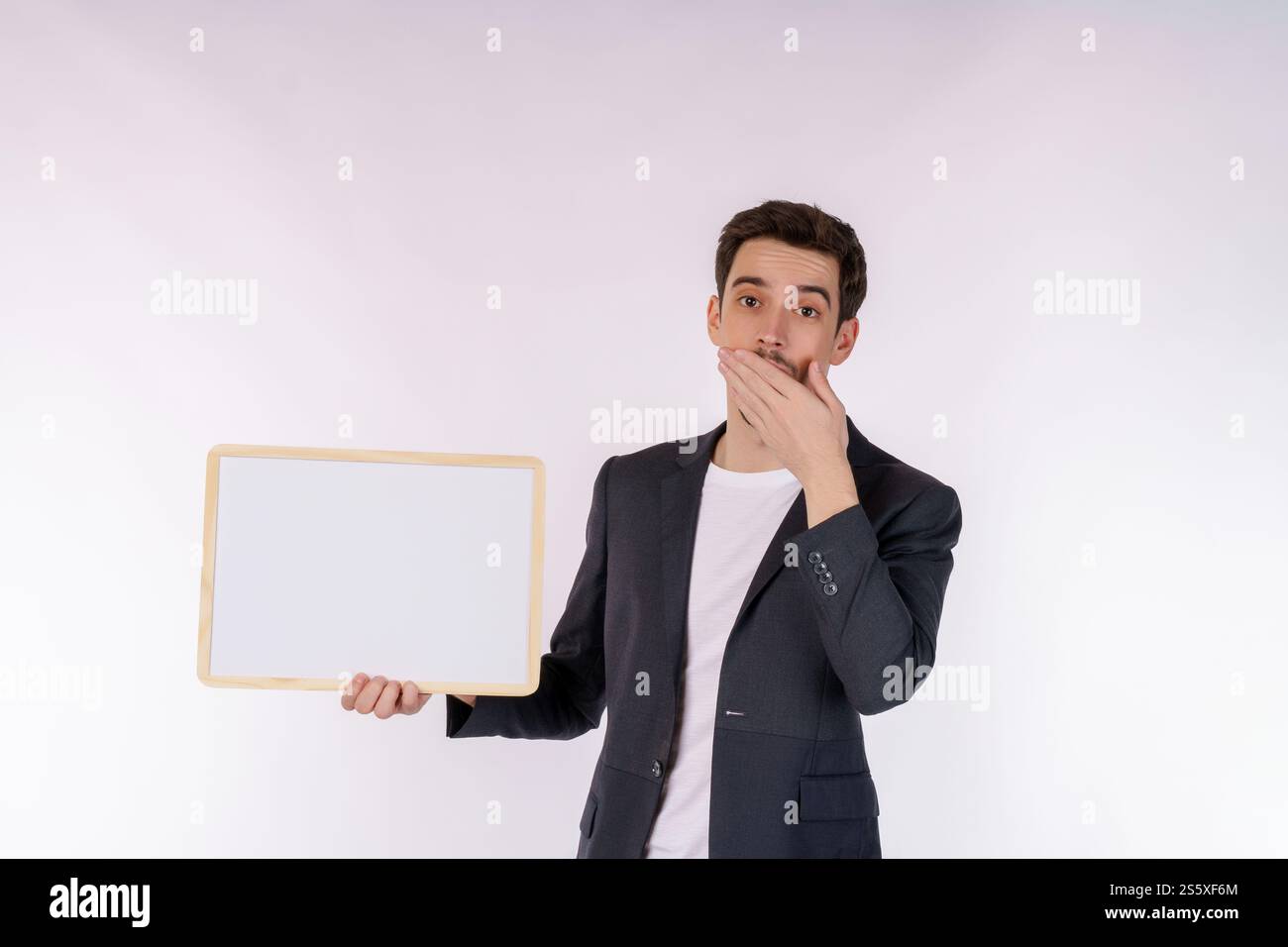 Portrait of happy businessman showing blank signboard on isolated white ...