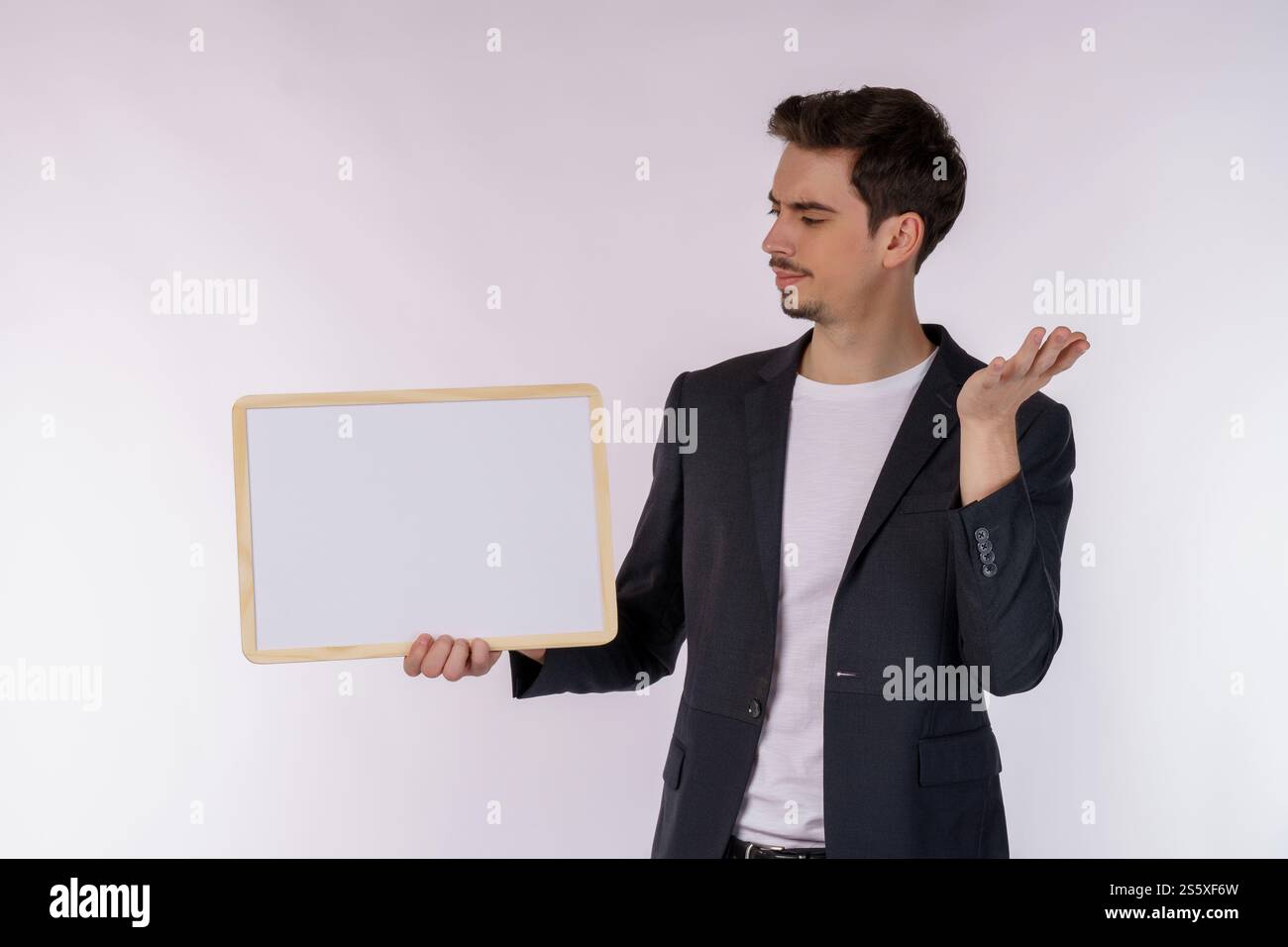 Portrait of happy businessman showing blank signboard on isolated white ...