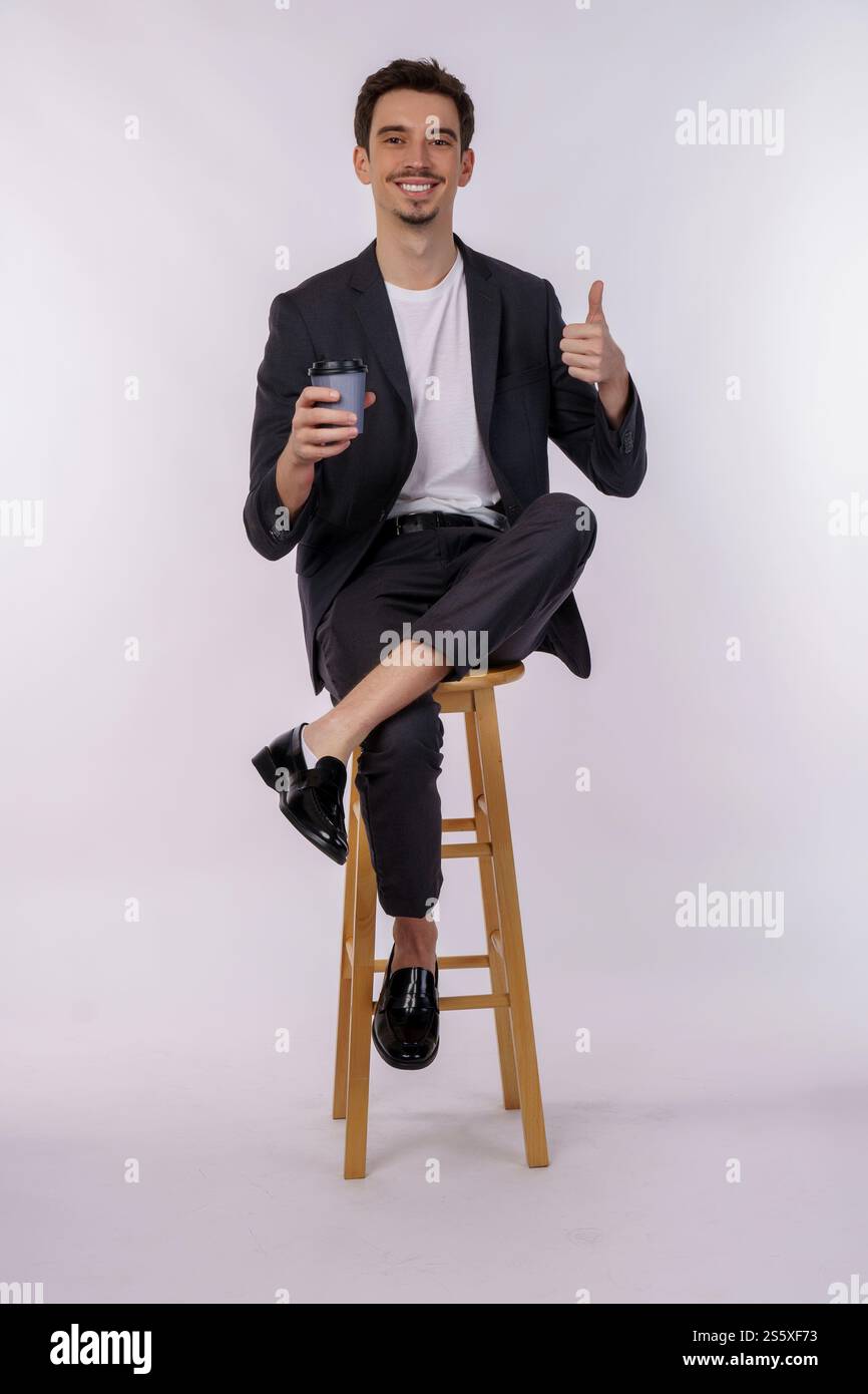 Portrait of happy smiling young businessman showing thumbs up gesture ...