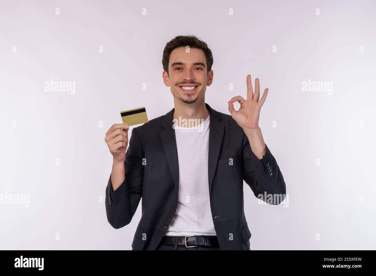 Portrait of Young smiling handsome businessman showing credit card and ...