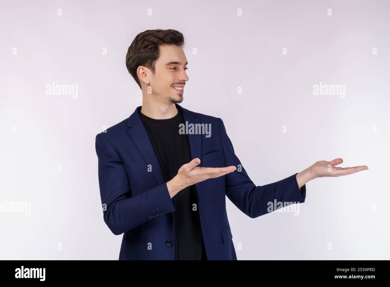Portrait of happy smiling young businessman presenting and showing your ...