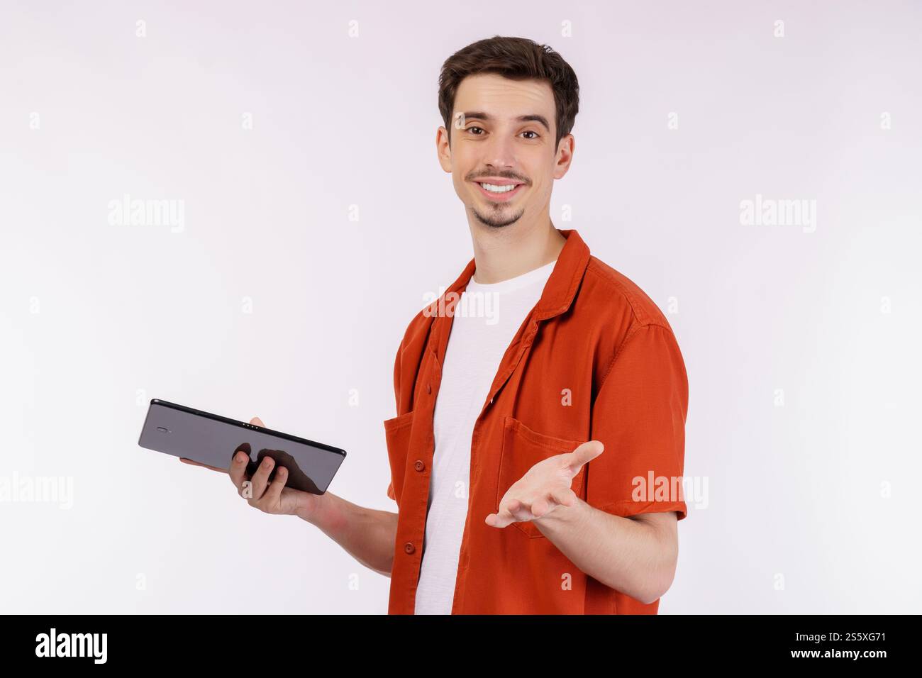 Portrait of attractive cheerful man using device app searching web ...