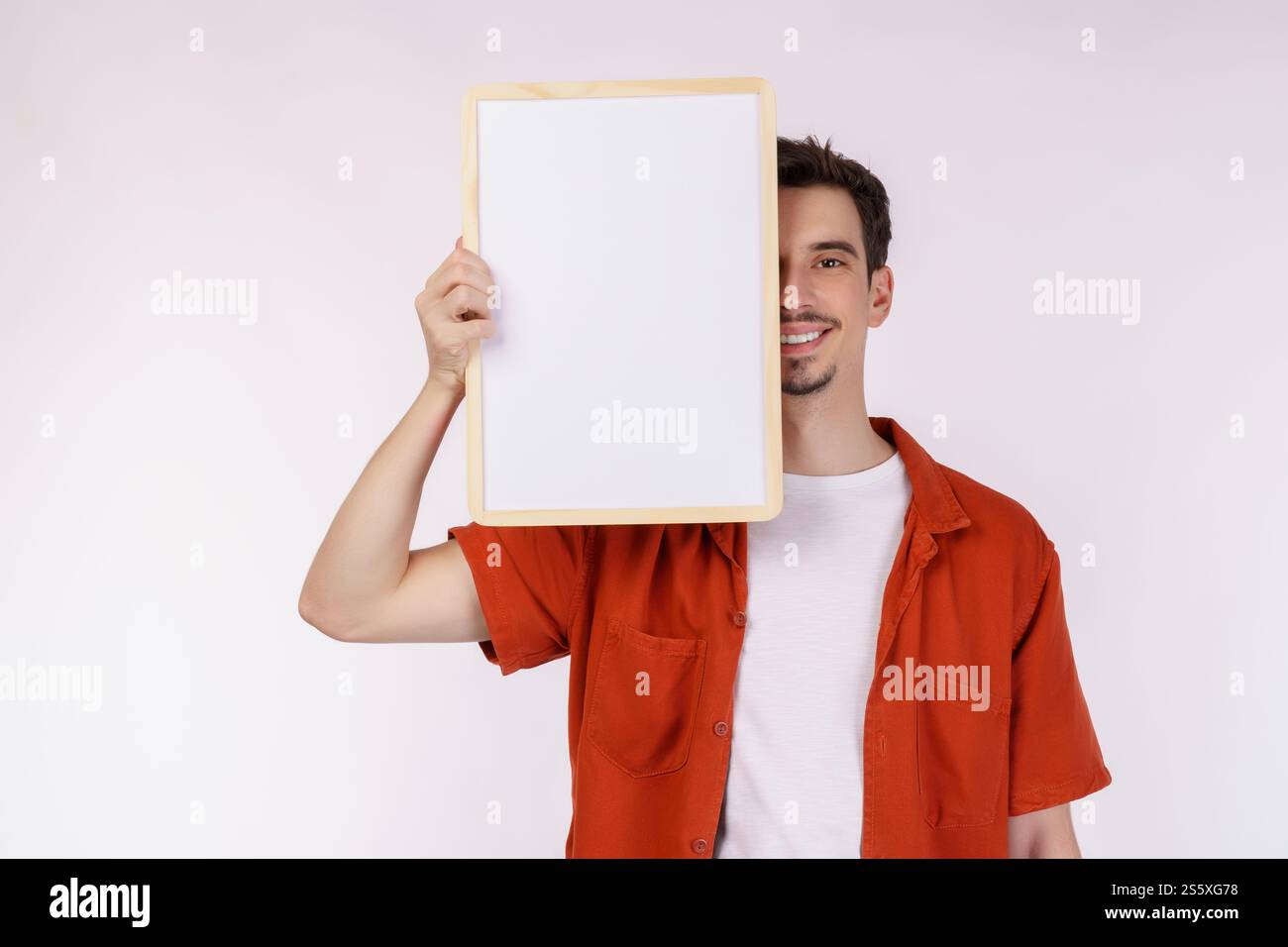 Portrait of happy man showing blank signboard on isolated white ...