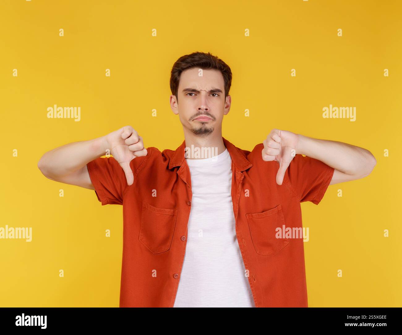 Portrait of young man shows sign of dislike, looks with negative ...
