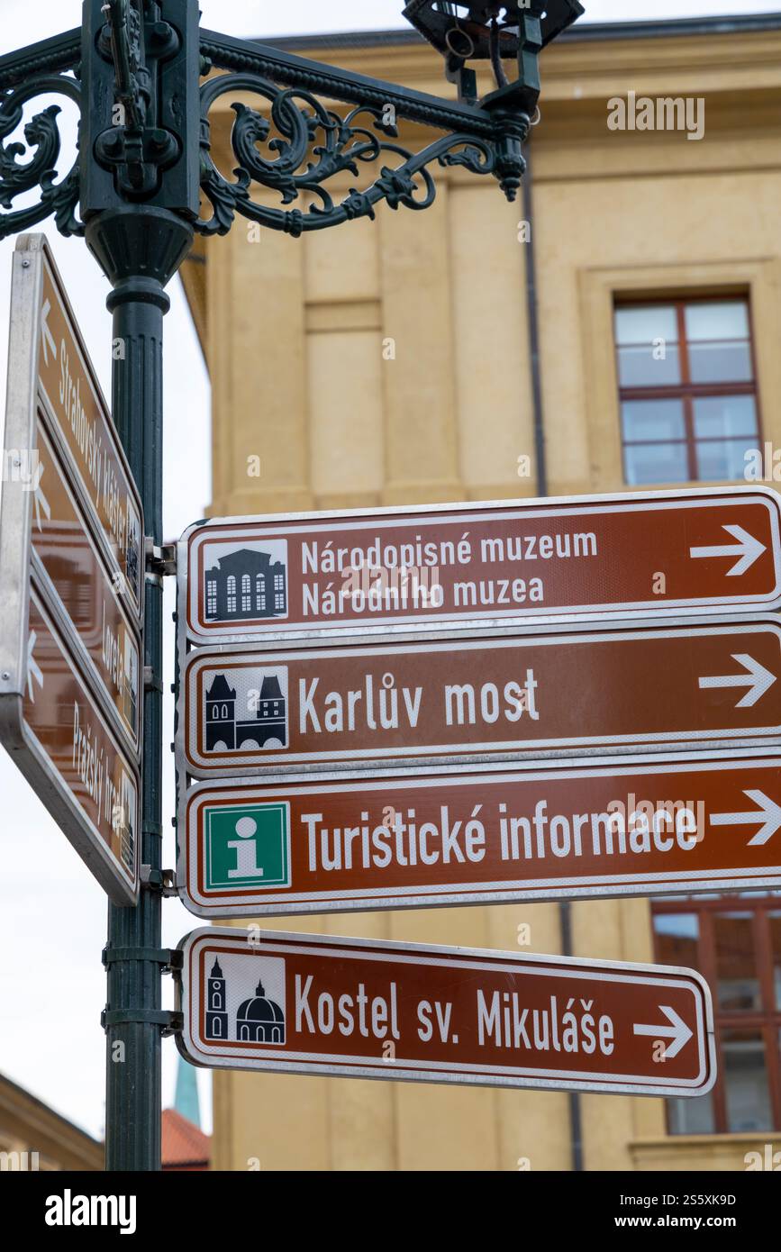 Prague city centre, street lamp lighting and brown tourist directions ...