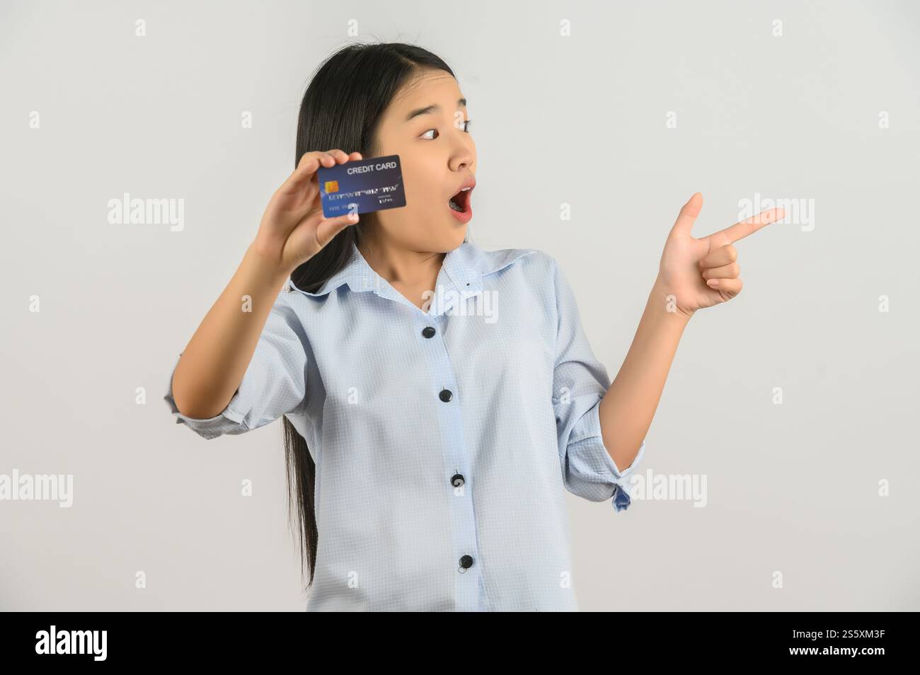 Portrait of positive young asian woman showing credit card good mood ...