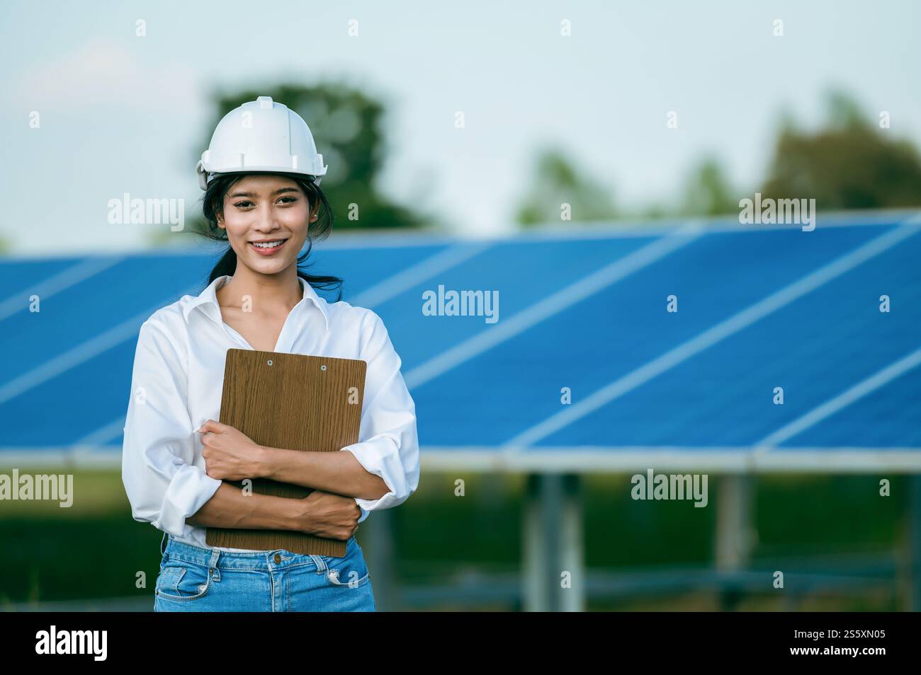 Portrait Asian Young engineer woman wearing protection helmet standing ...