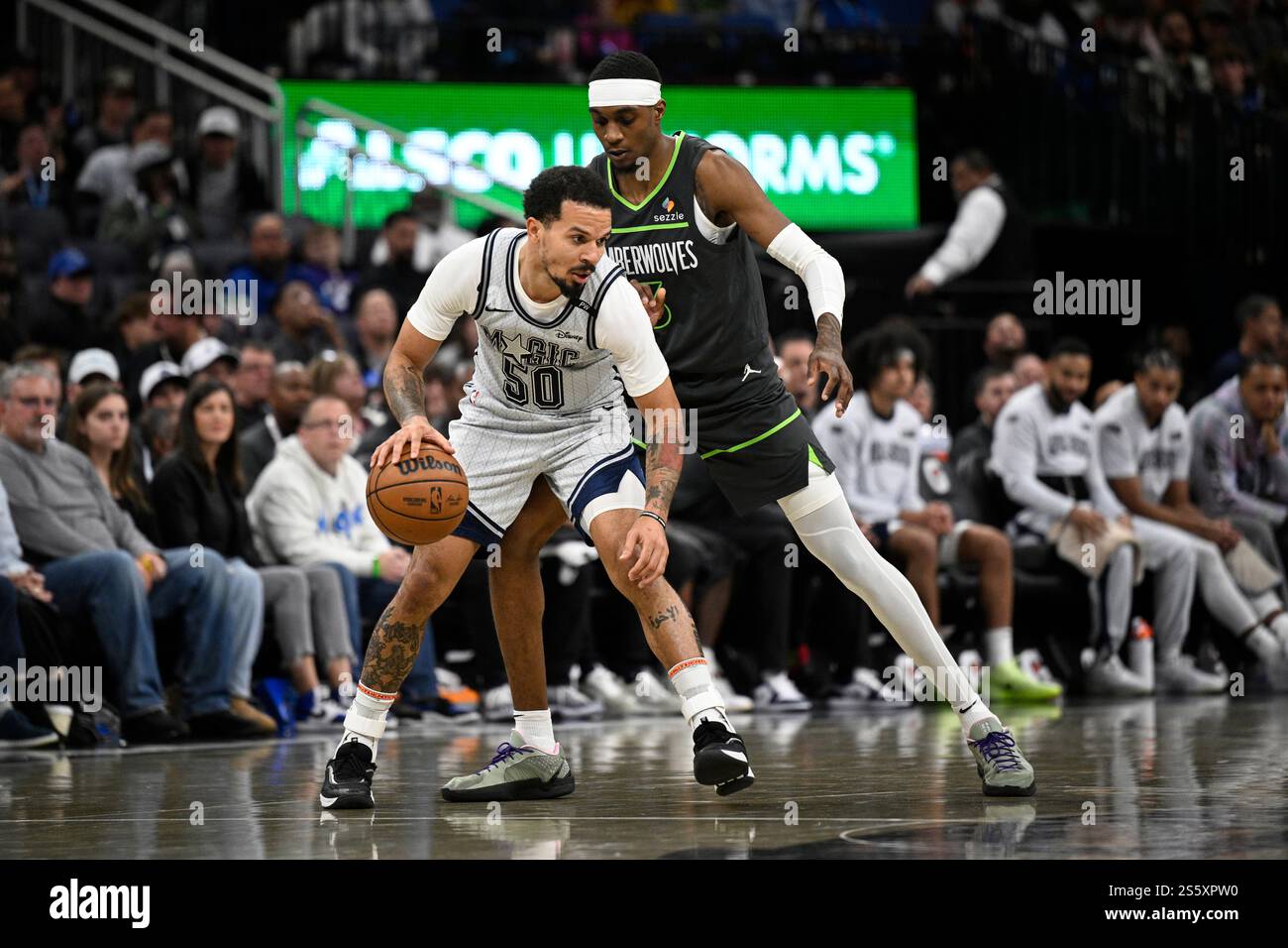 Orlando Magic guard Cole Anthony (50) is defended by Minnesota ...