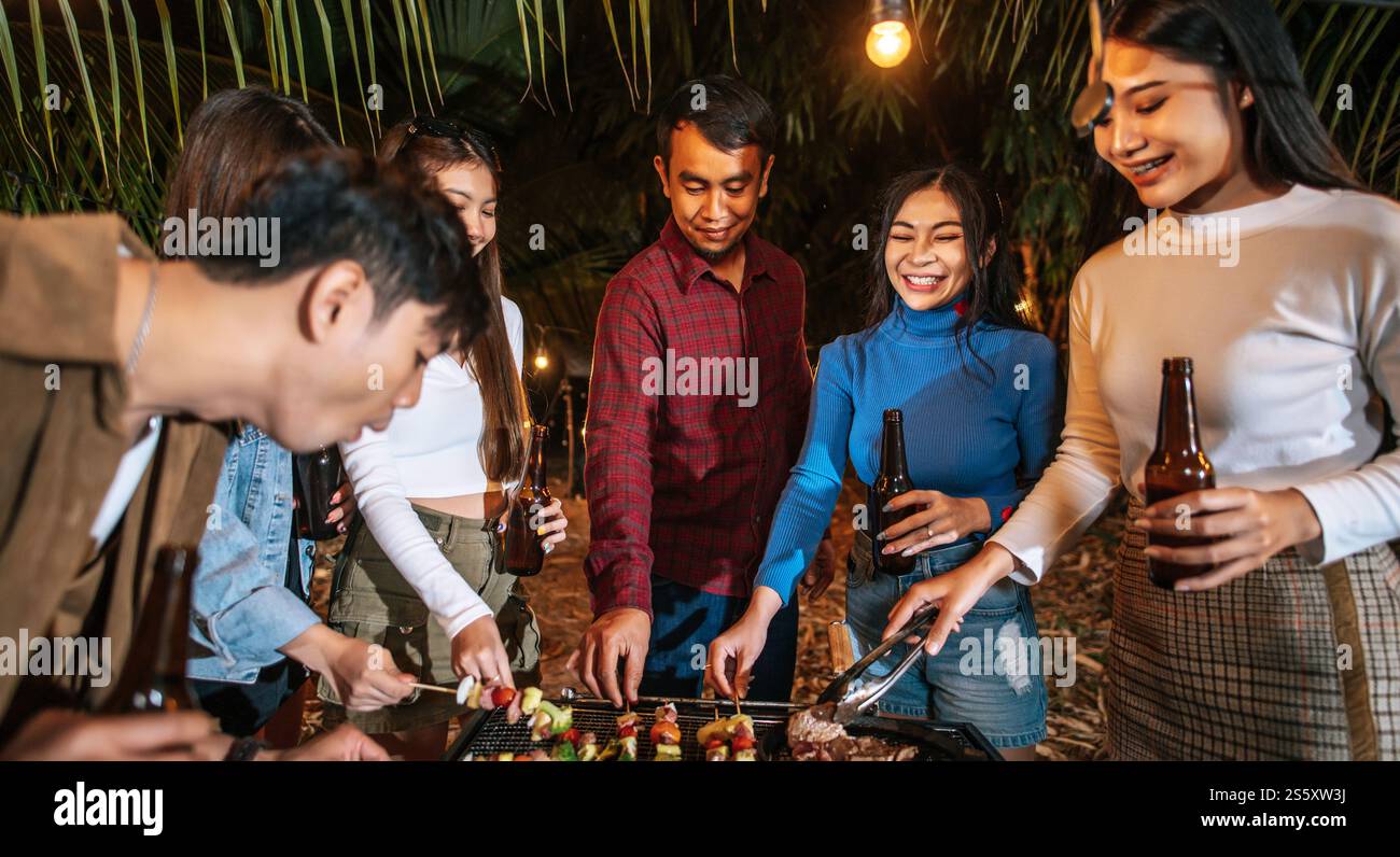 Happy Asian friends cheering with barbecue dinner outdoor - Group of ...