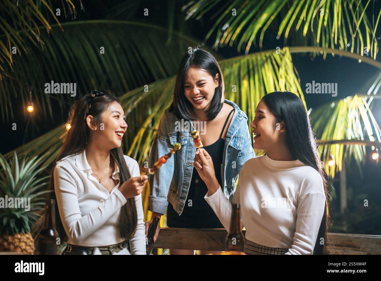 Happy Asian friends cheering with barbecue dinner outdoor - Group of ...